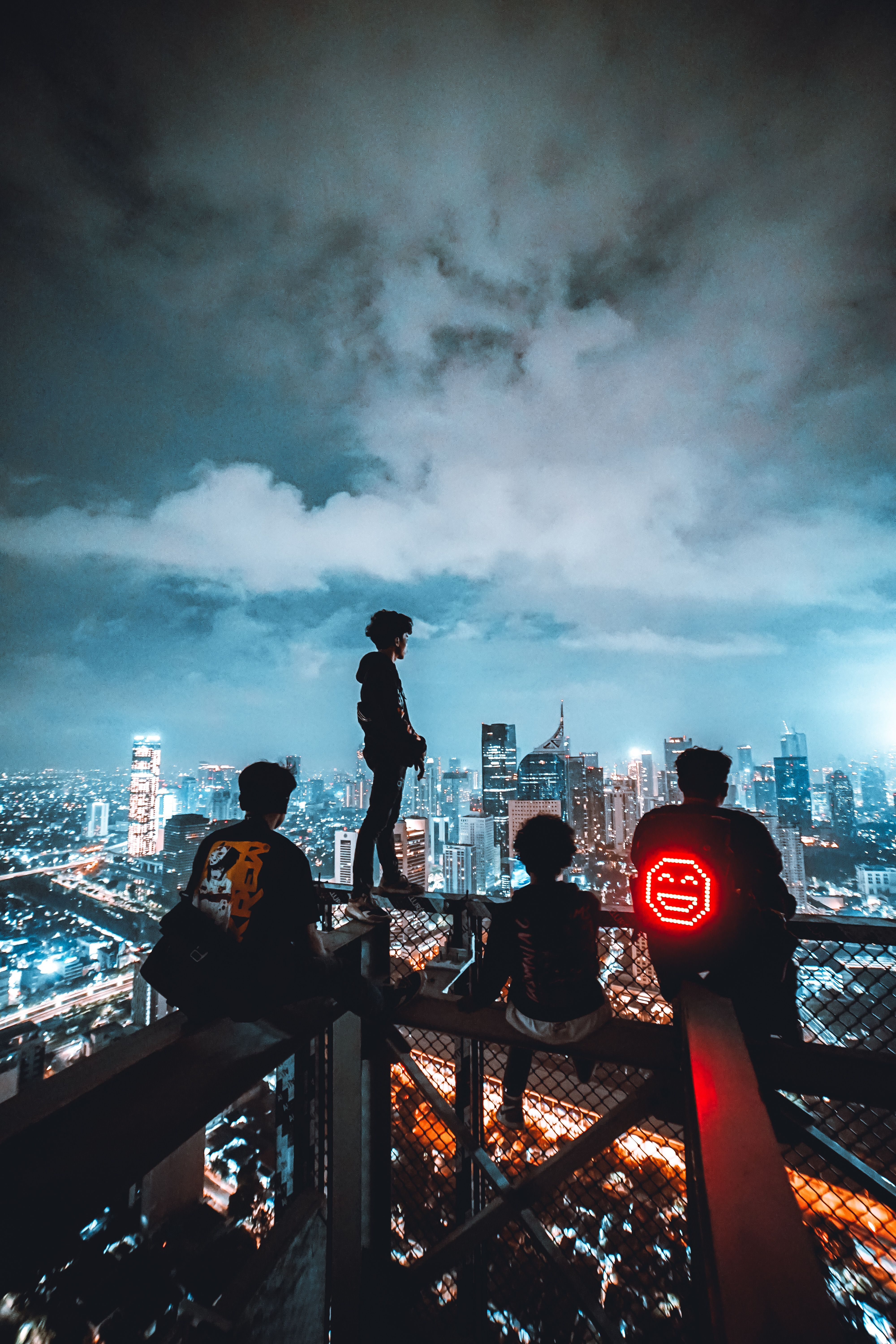 People Sitting on Top of Building during Night Time · Free Stock Photo