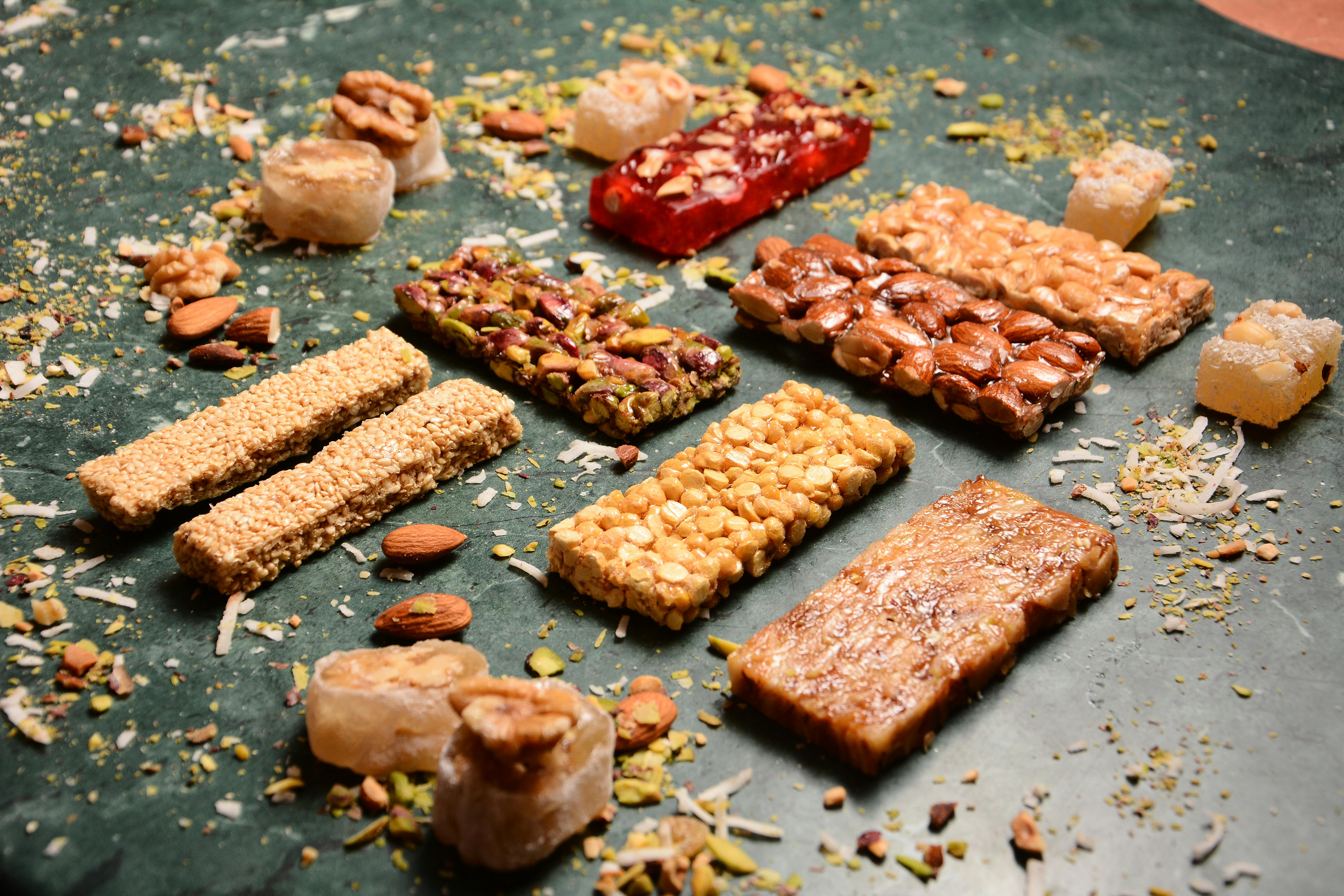 Assorted Bars of Nuts on Black Surface · Free Stock Photo