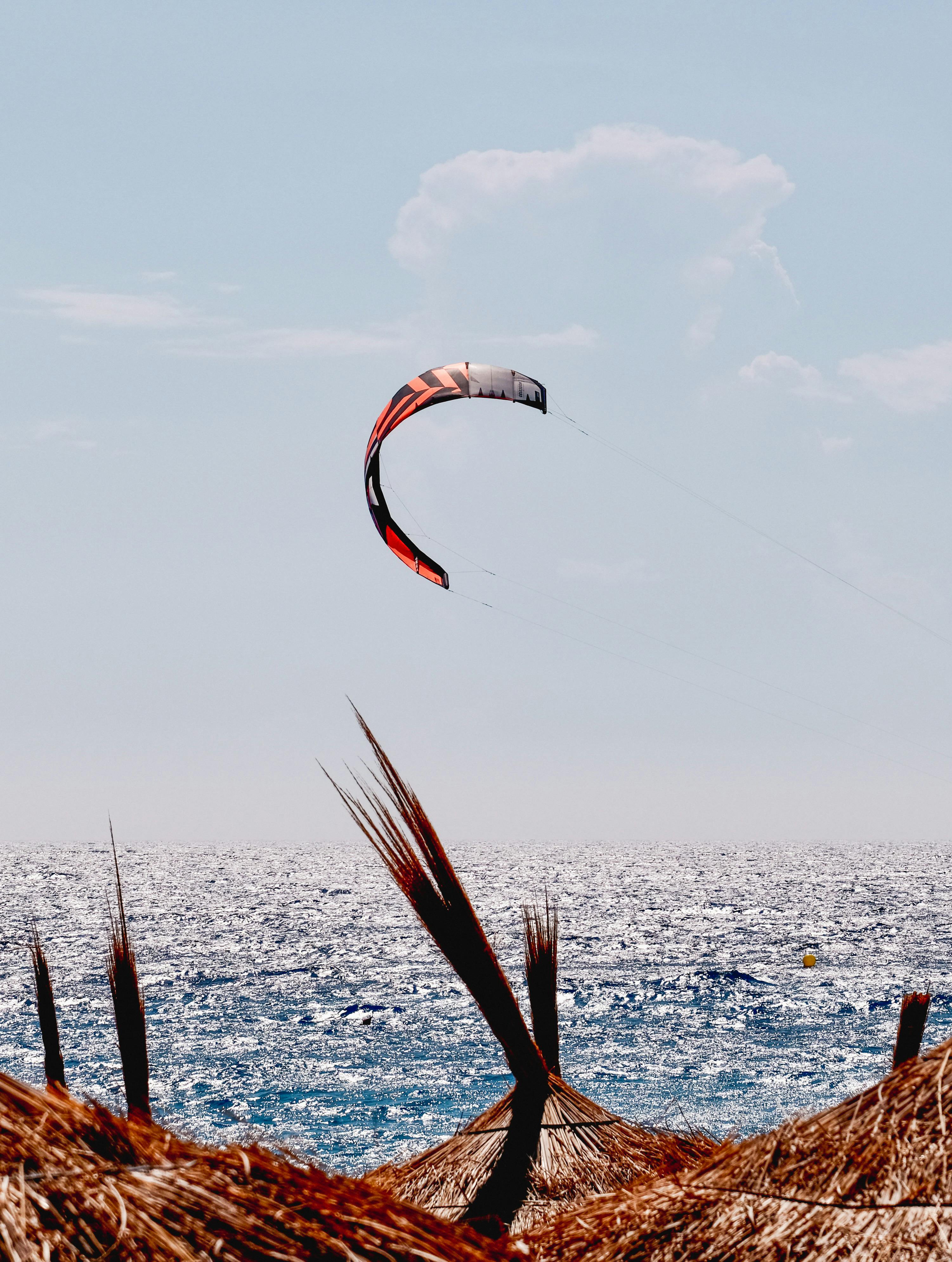 A Paraglider Above Body of Water · Free Stock Photo