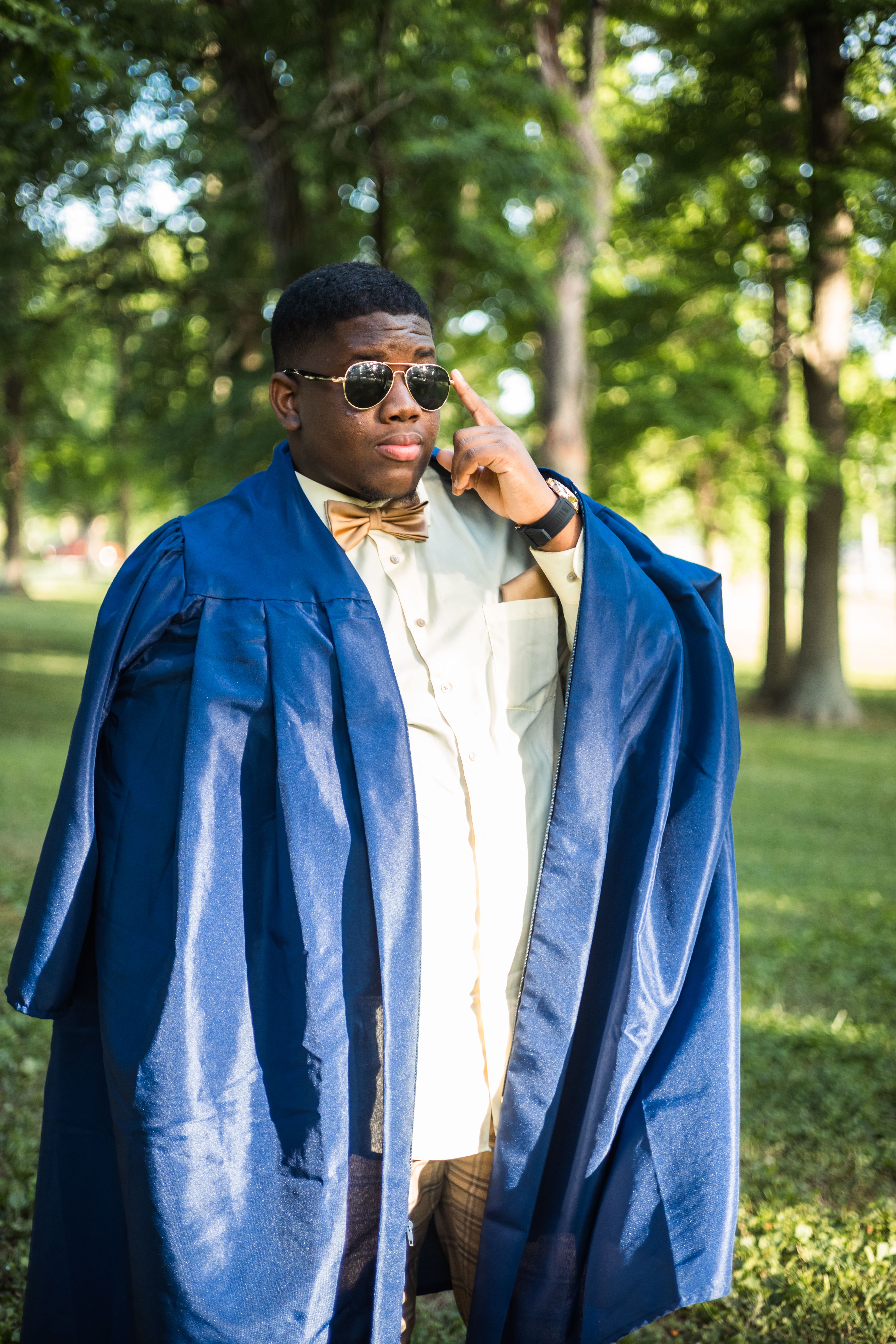 Man in Blue Graduation Gown Wearing Black Sunglasses · Free Stock Photo