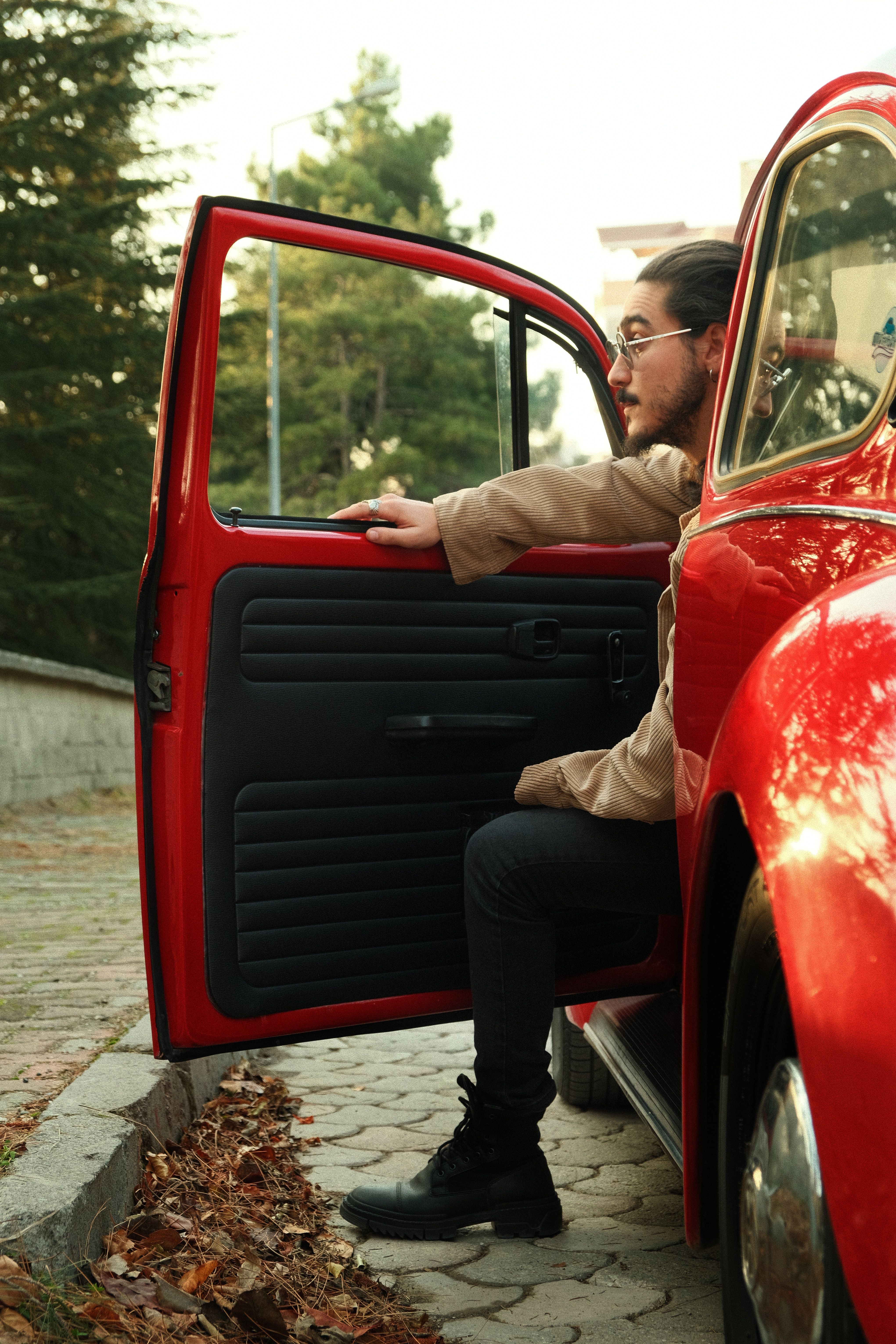 A Man Sitting in a Red Car · Free Stock Photo