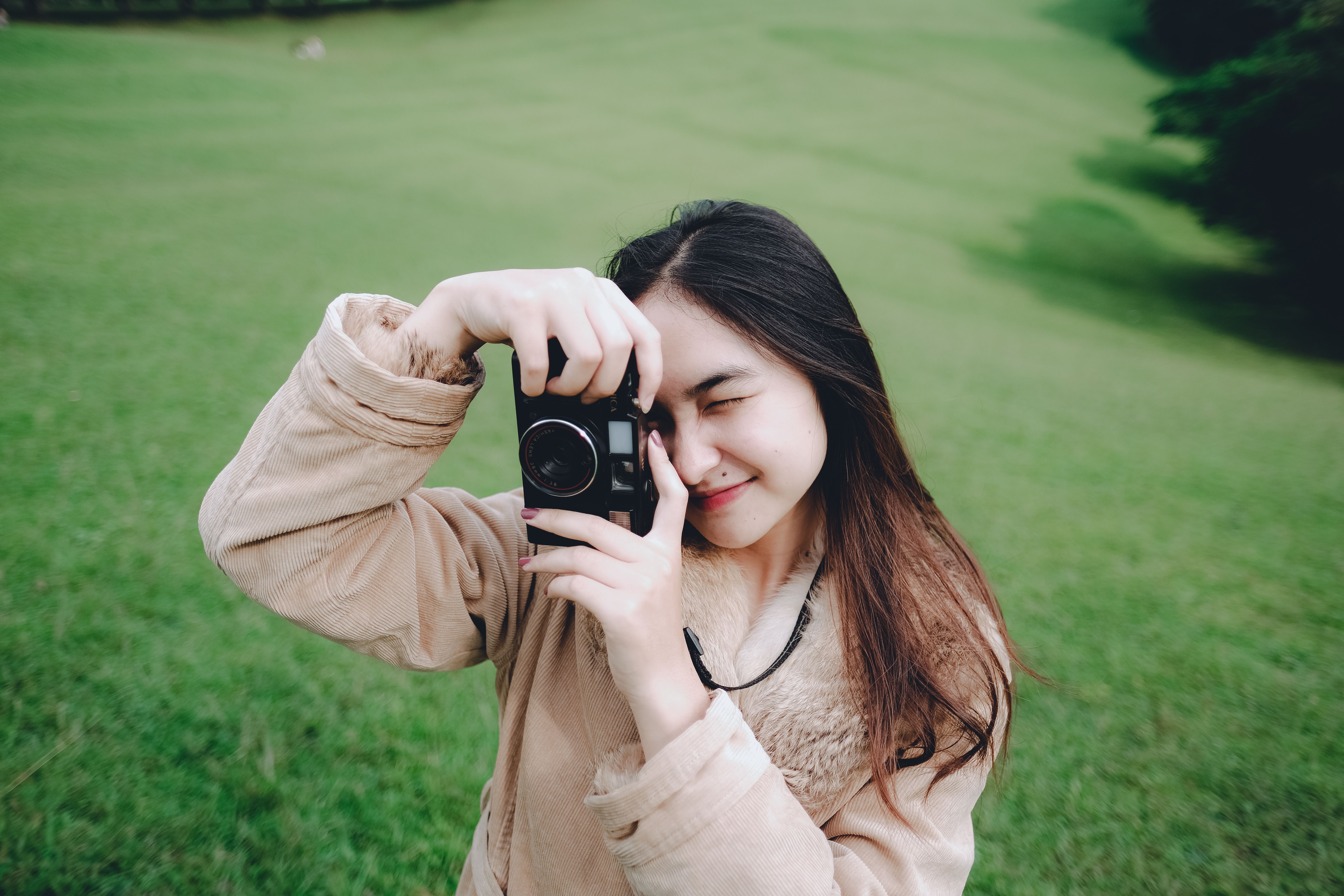 Woman With a Camera Taking Pictures · Free Stock Photo