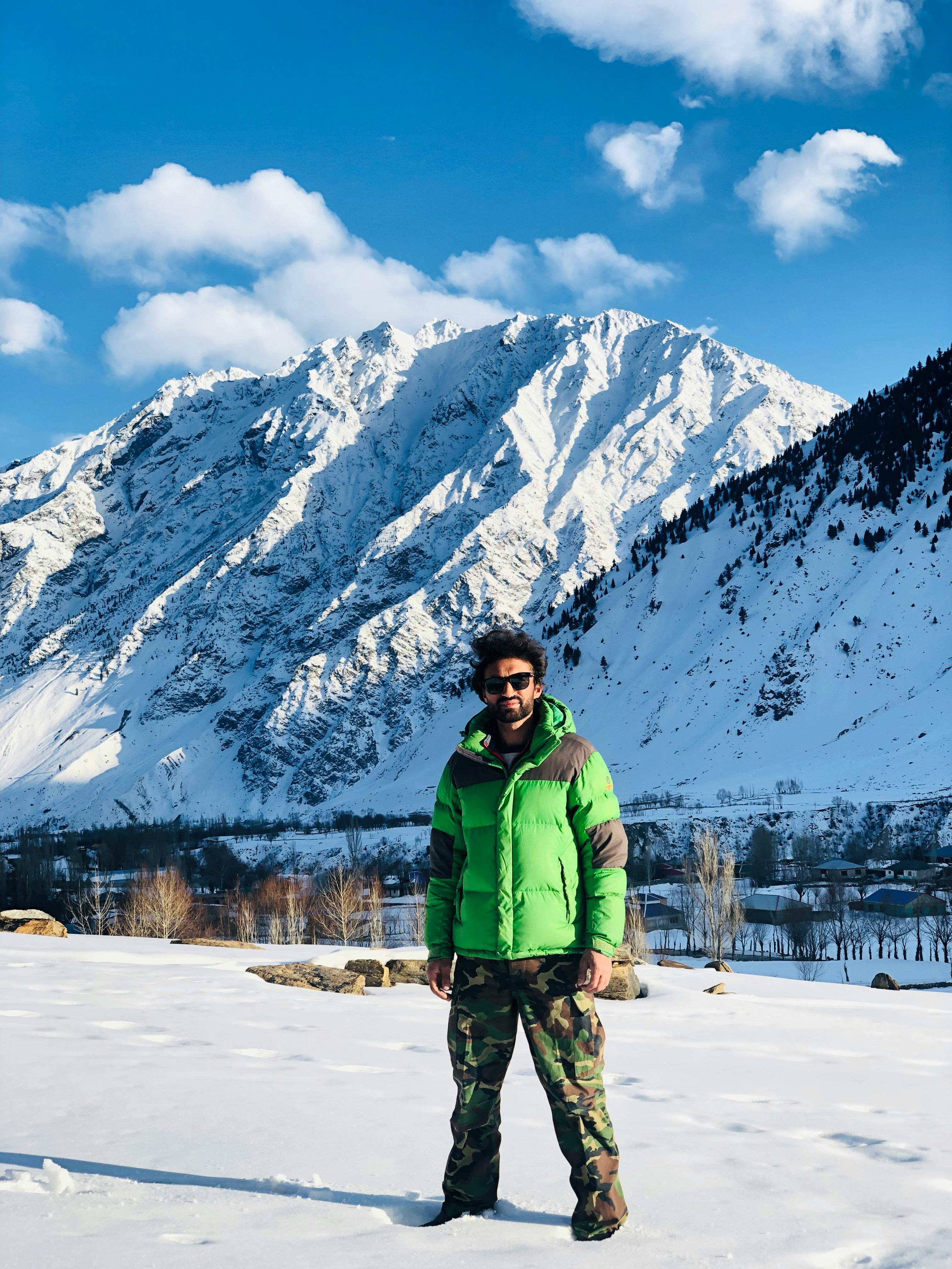 Man Standing on Snow Near Mountains · Free Stock Photo