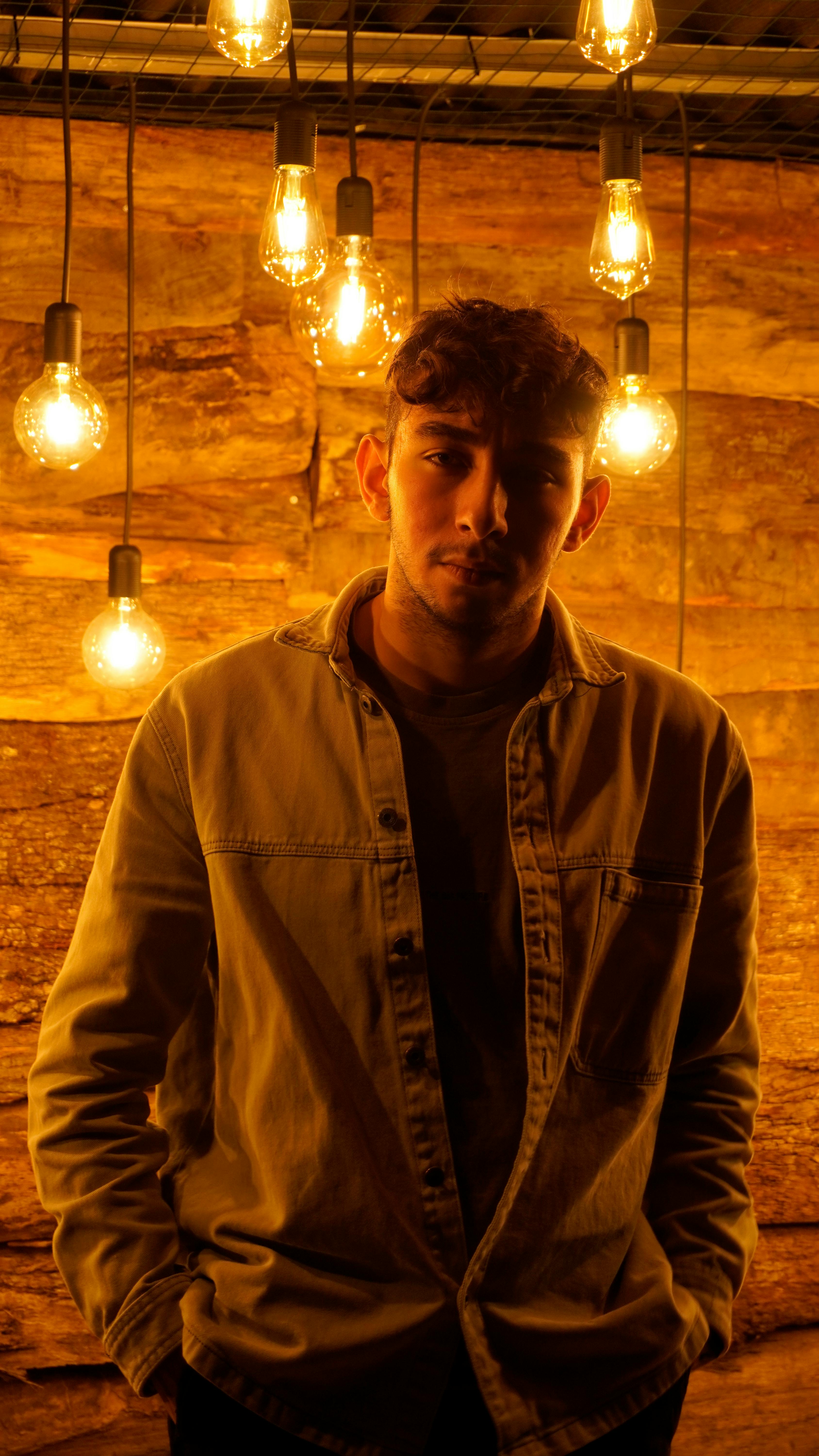 Man with Light Bulbs behind · Free Stock Photo