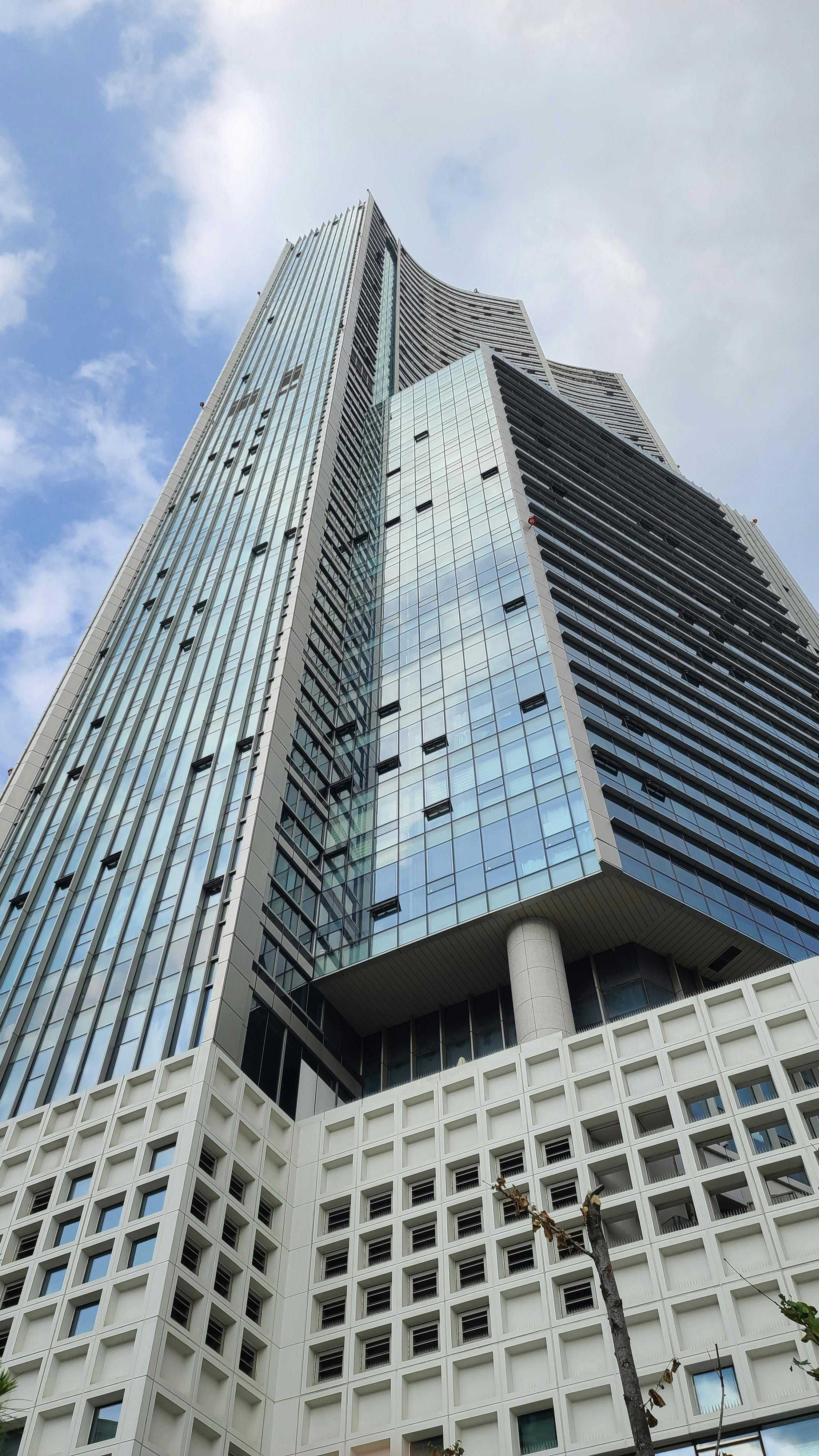 Facade of contemporary skyscraper against blue sky · Free Stock Photo