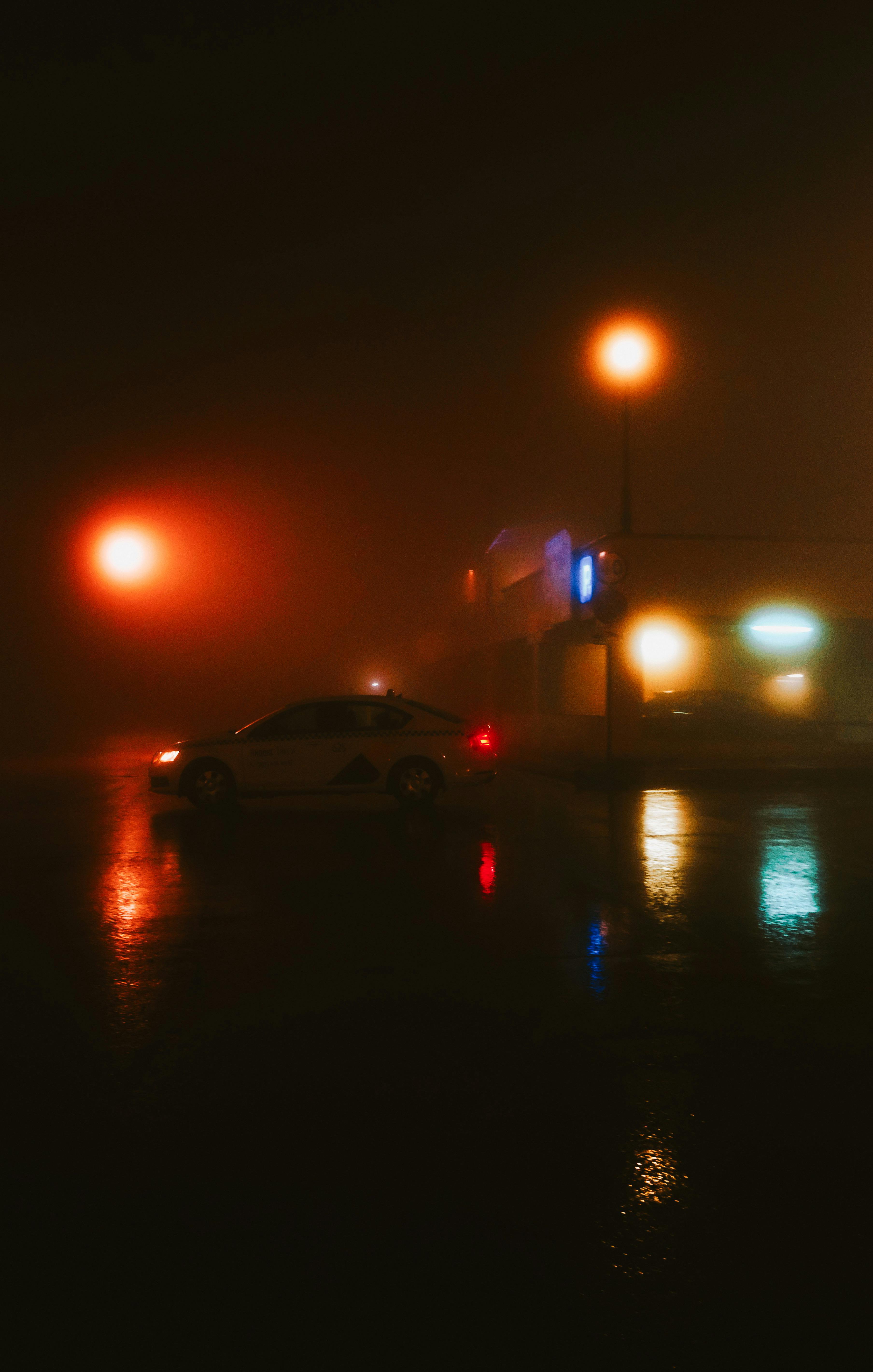 A Car on the Road During Rainy Night · Free Stock Photo