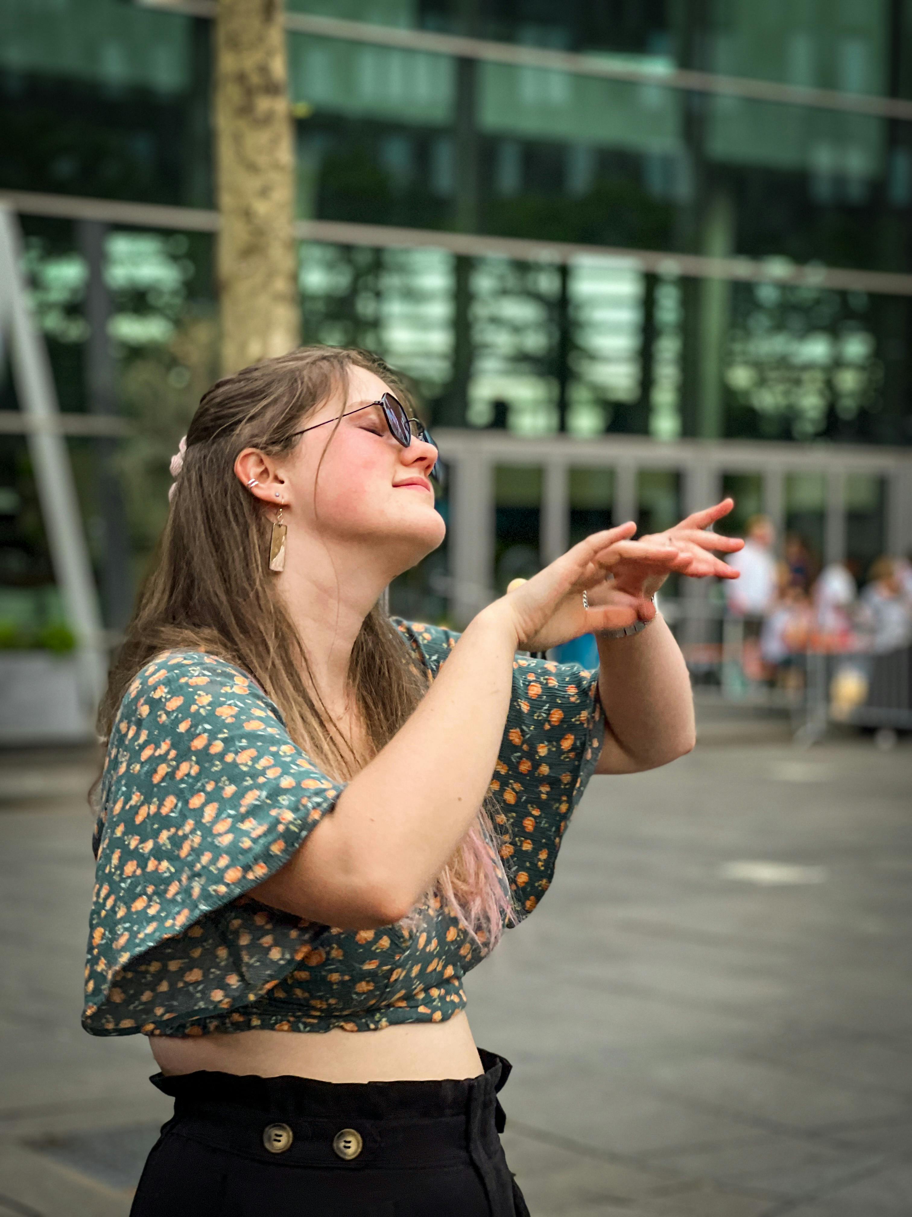 A Woman in Green Crop Top Dancing on the Street · Free Stock Photo