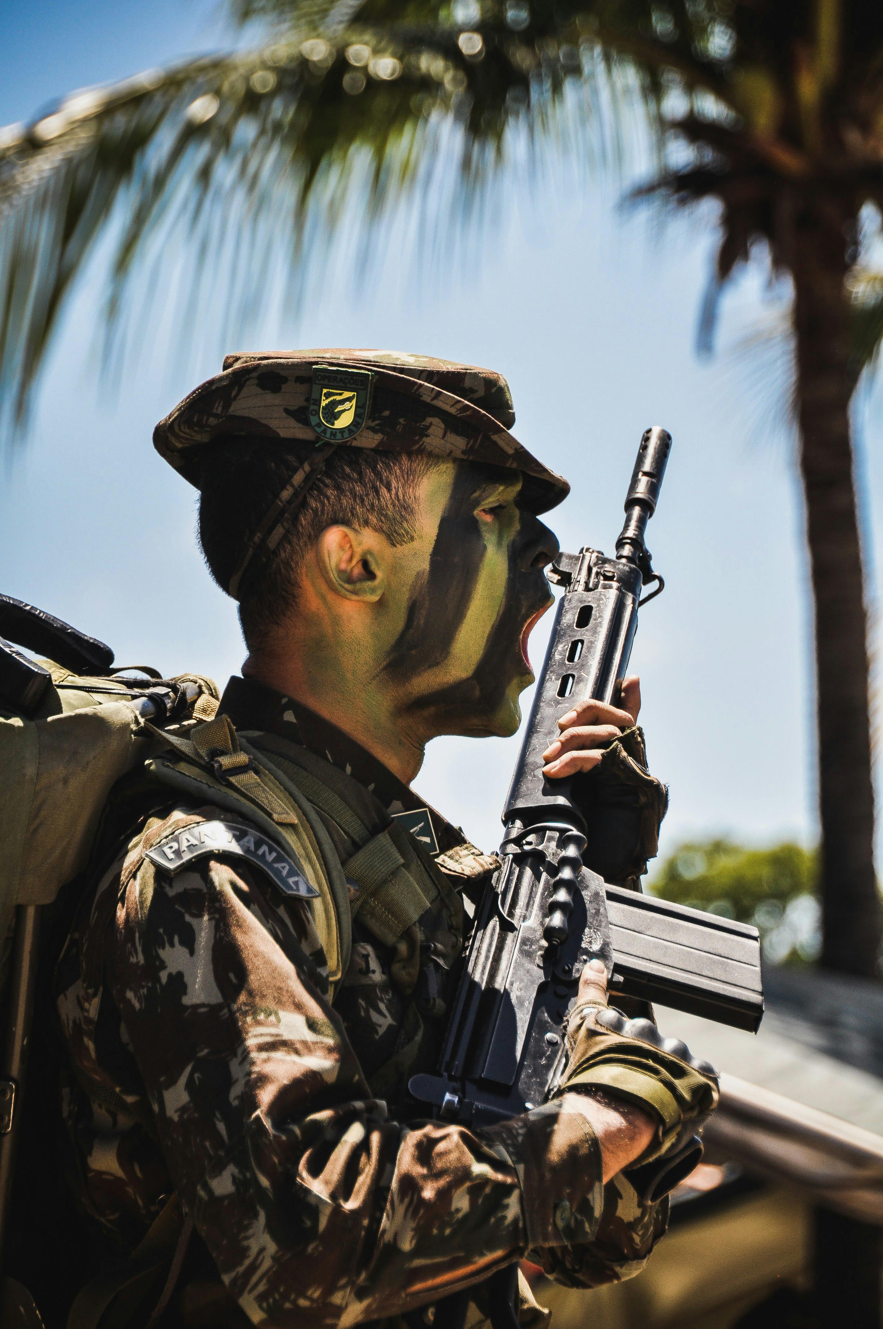 A Man Holding a Rifle · Free Stock Photo