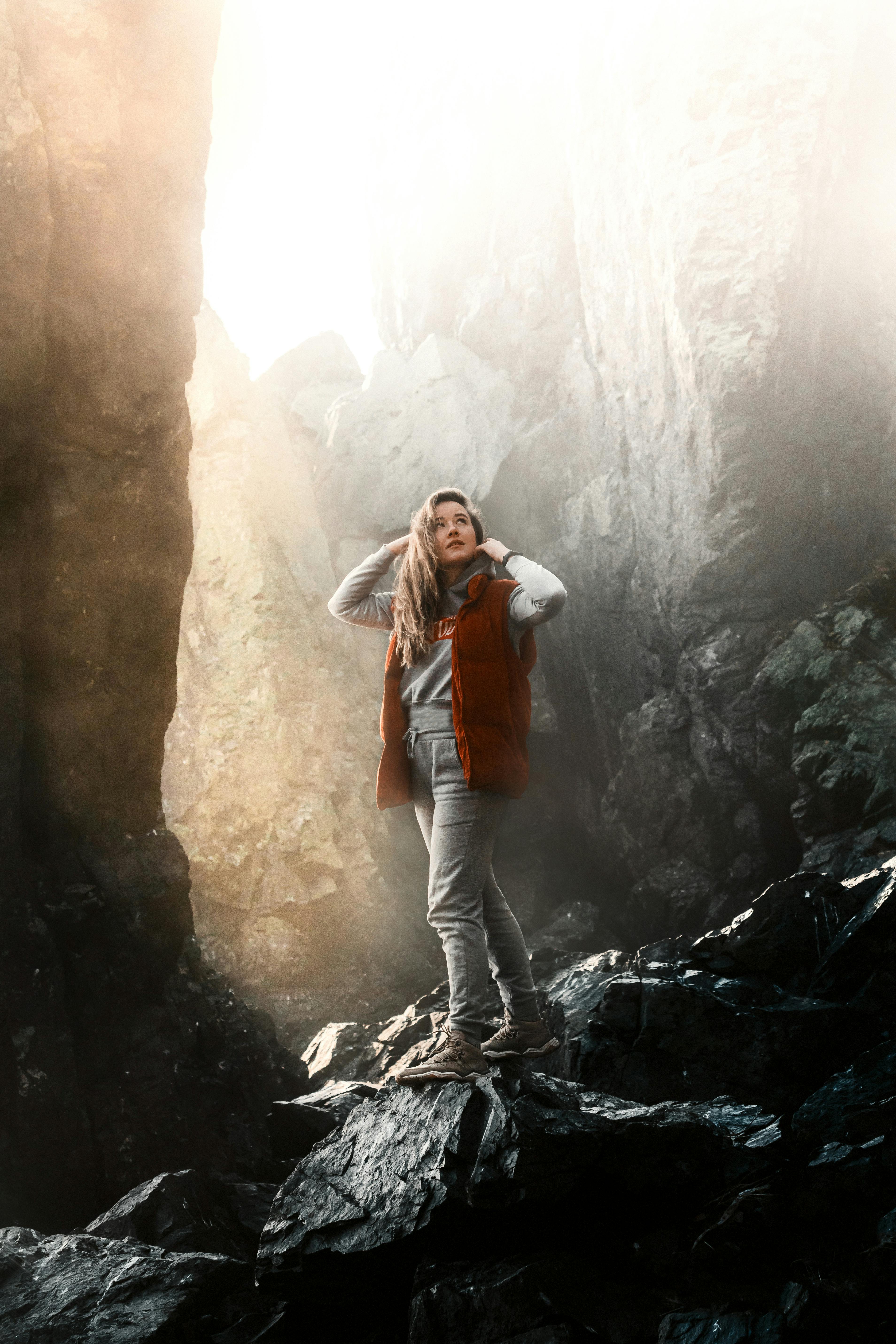 Hiker Looking into the Abyss from the Edge of a Rock · Free Stock Photo
