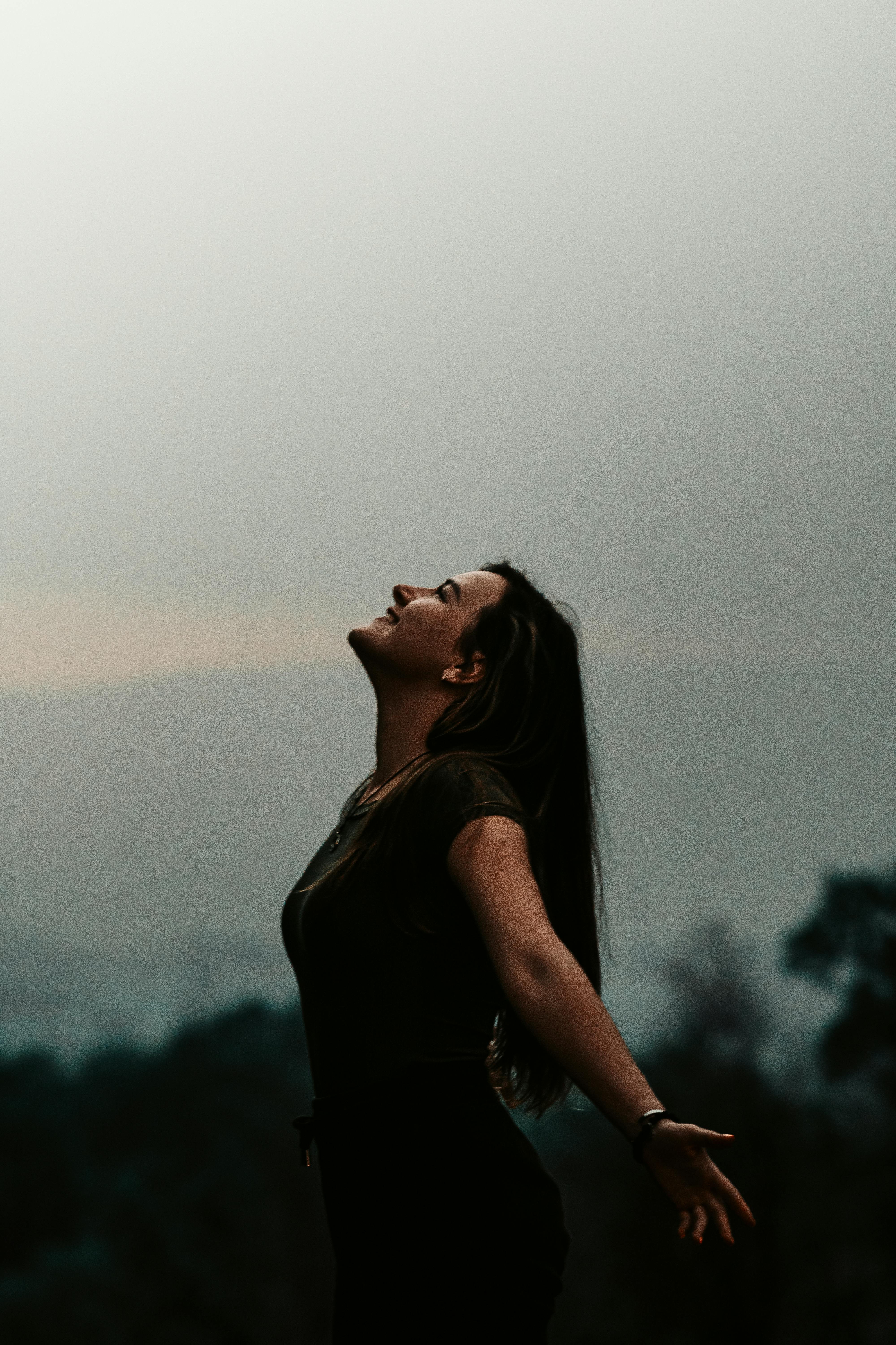 Woman with Arms Apart Looking Up in the Sky · Free Stock Photo