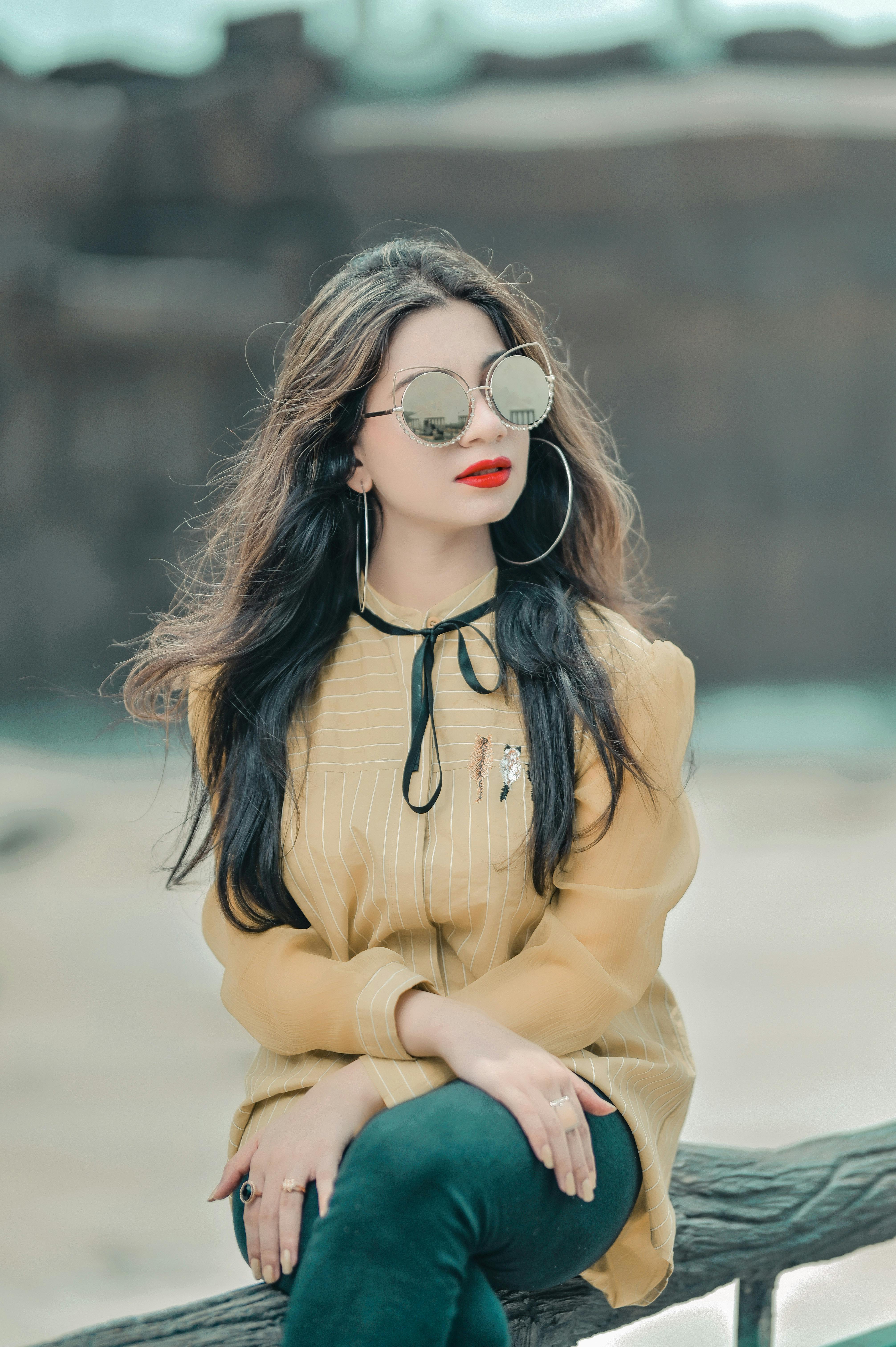 Woman Sitting on Railing · Free Stock Photo