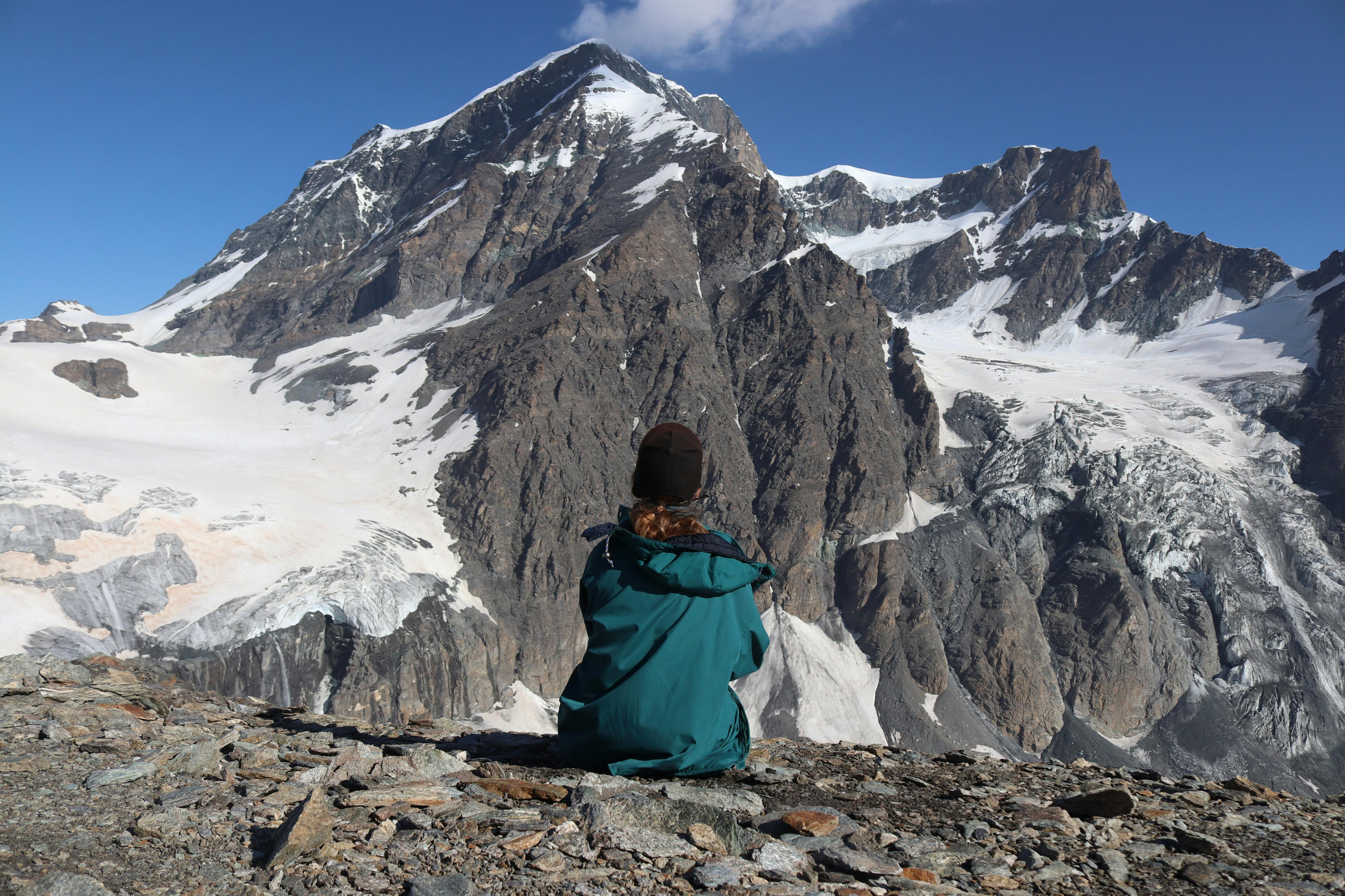 Back View of a Person Sitting on the Ground · Free Stock Photo