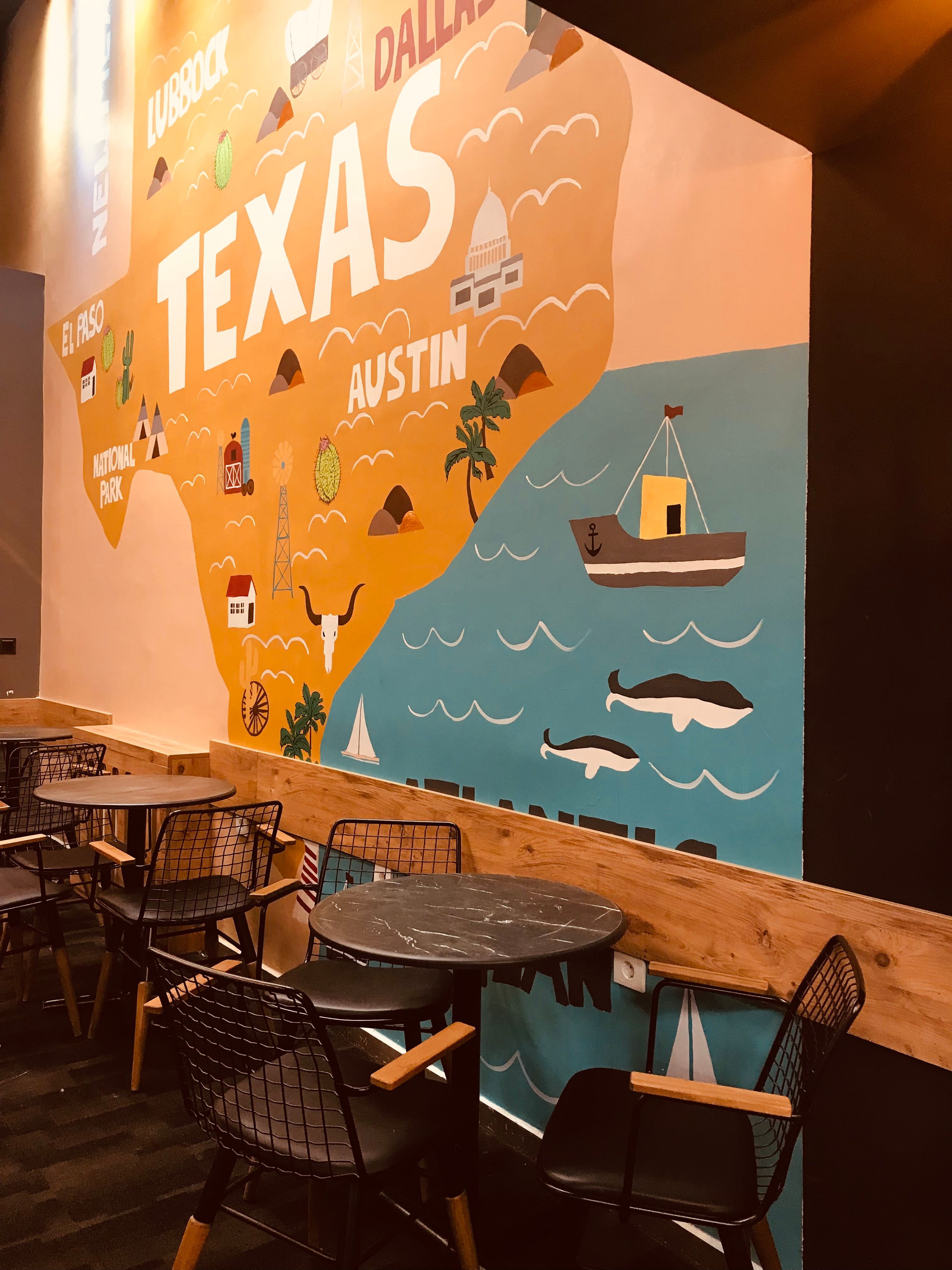 Brown Tables and Chairs Beside Wall with Mural · Free Stock Photo