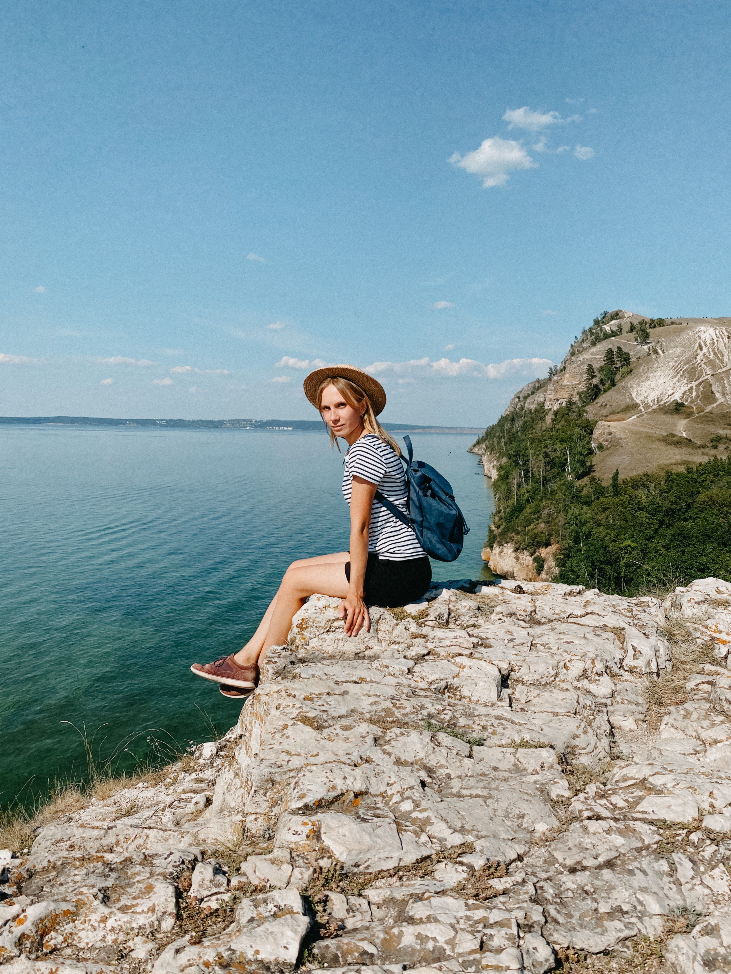 Photo of a Woman Sitting on the Cliff · Free Stock Photo