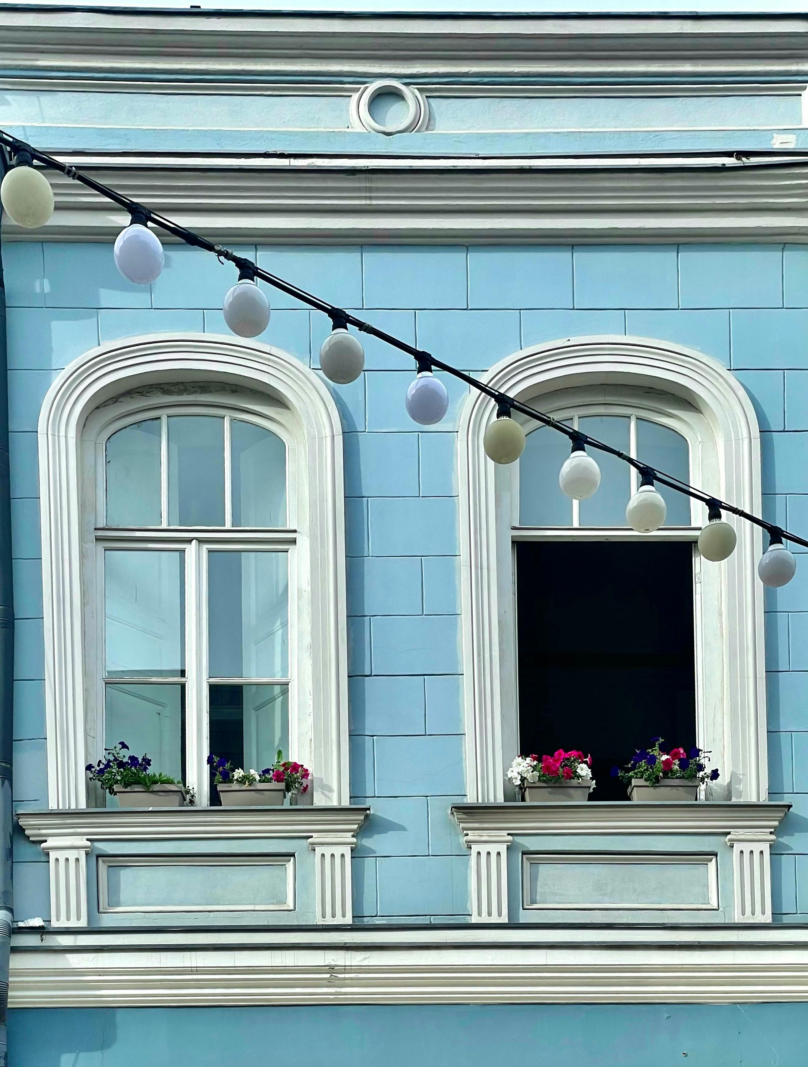 Blue Building Facade with Arched Windows with Flower Containers · Free ...