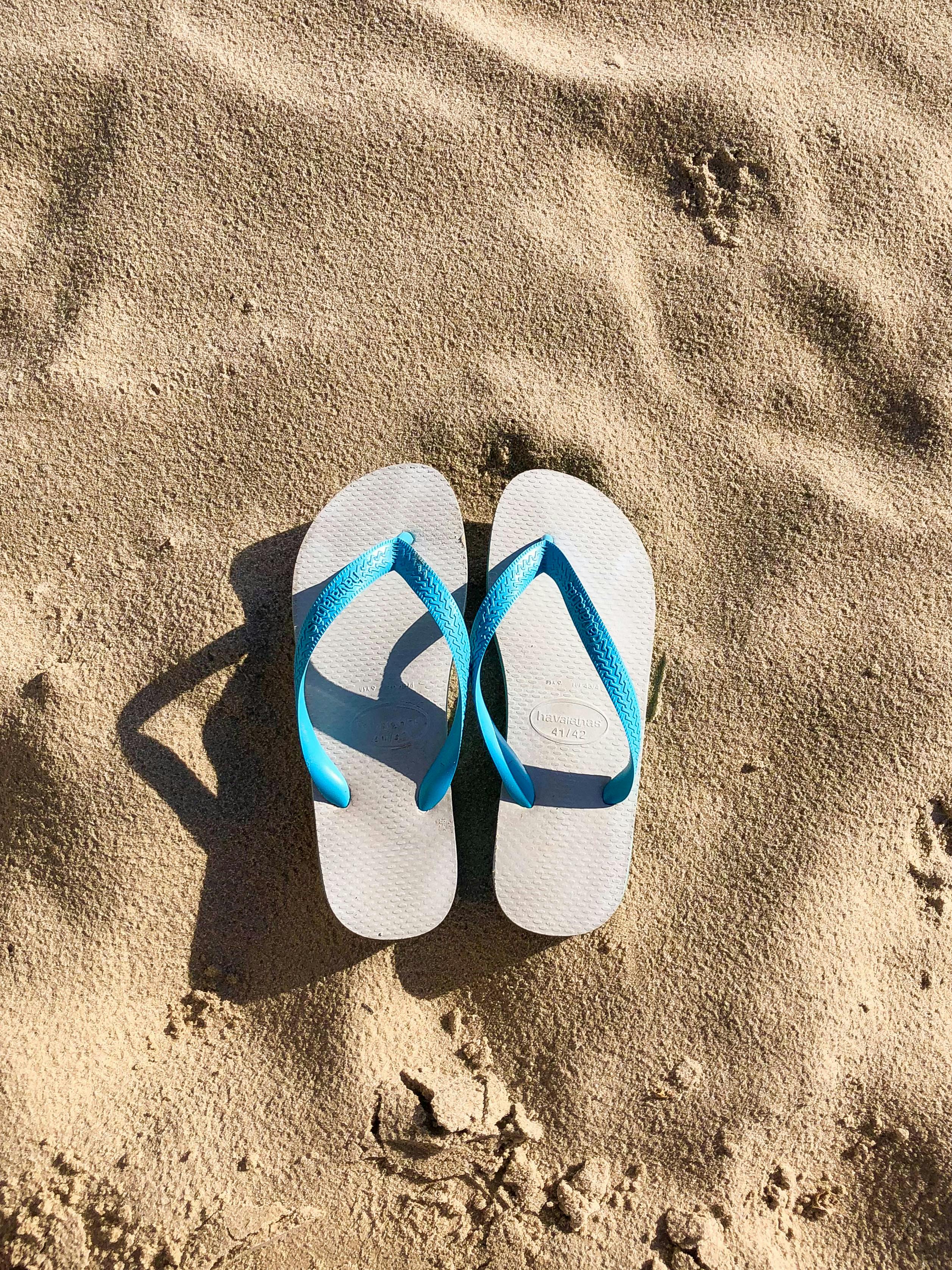 A Pair of Flip Flops on the Sand · Free Stock Photo