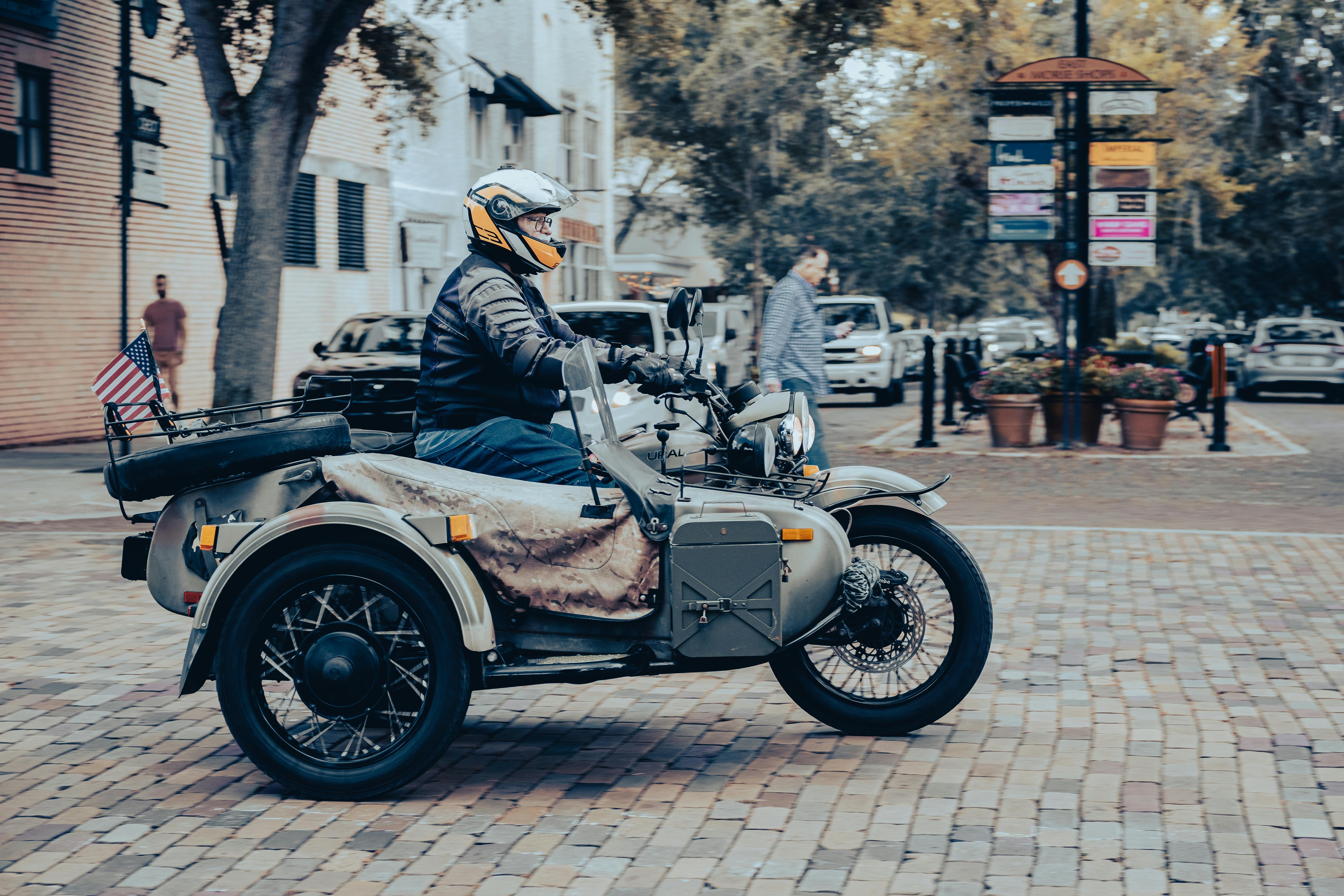 Man in Motorcycle Driving through Street · Free Stock Photo