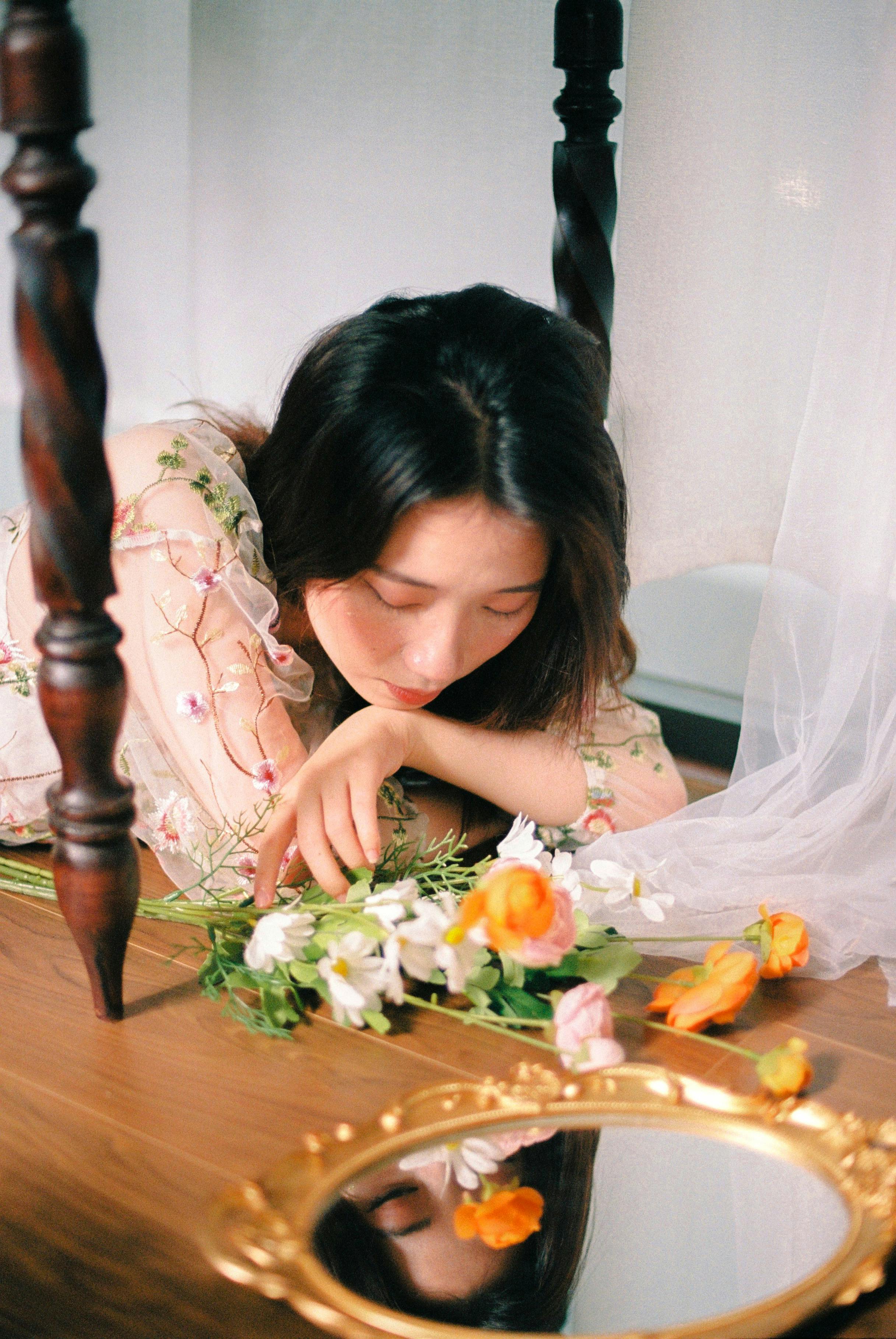 Photo of a Woman Looking at Flowers · Free Stock Photo