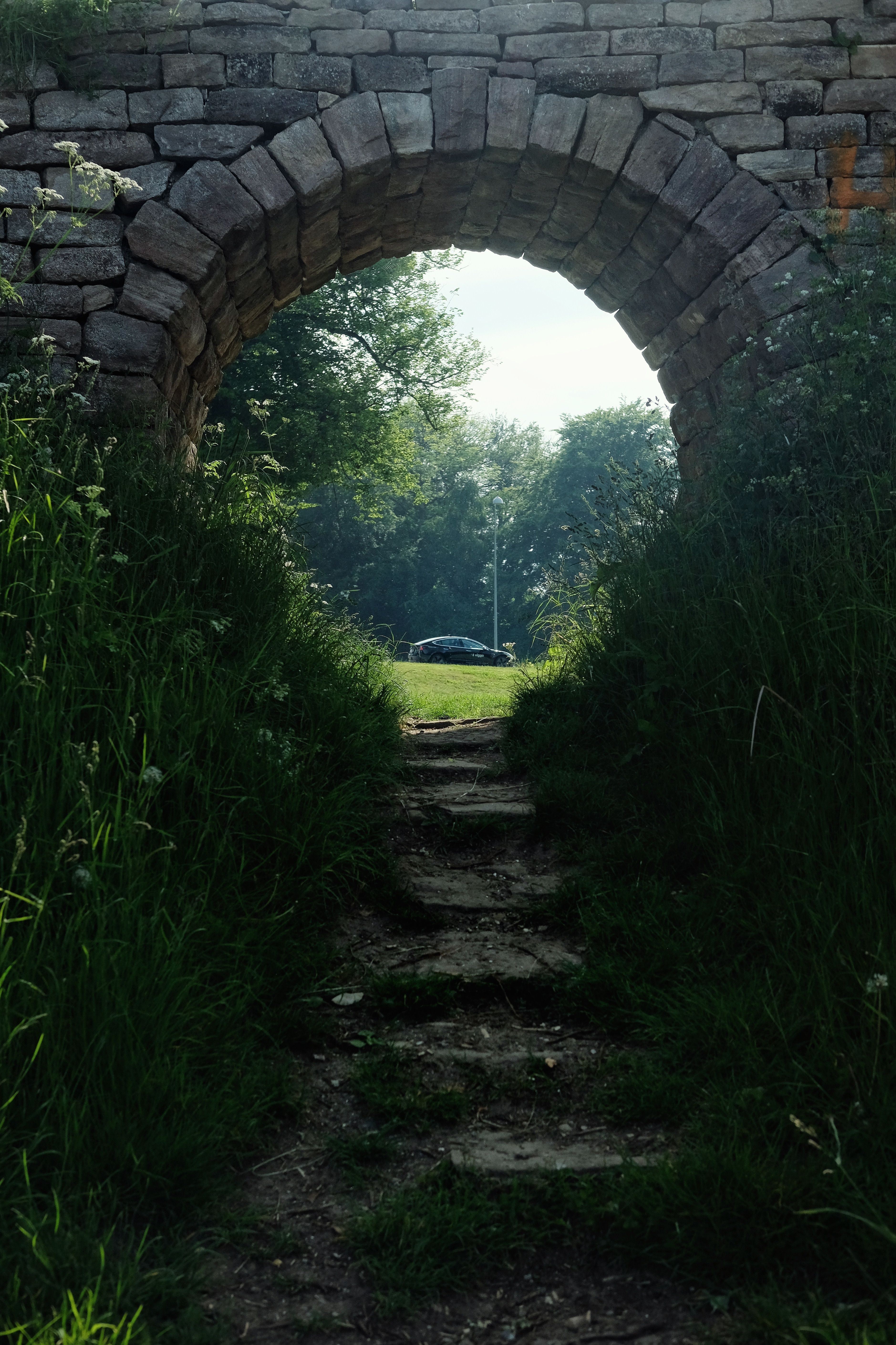 Pathway Under an Arch Stone Bridge · Free Stock Photo