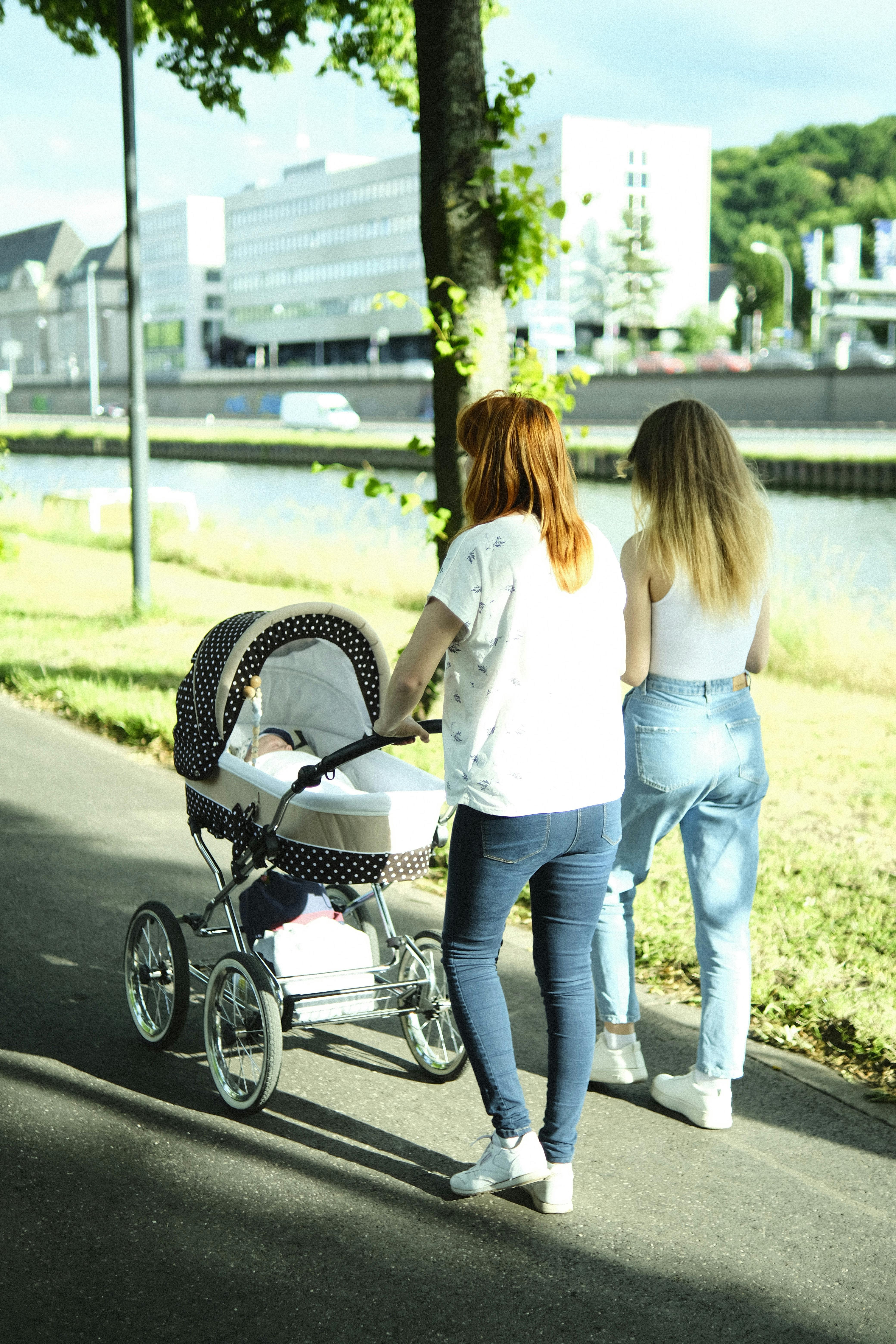 Women Walking with Baby in Stroller · Free Stock Photo