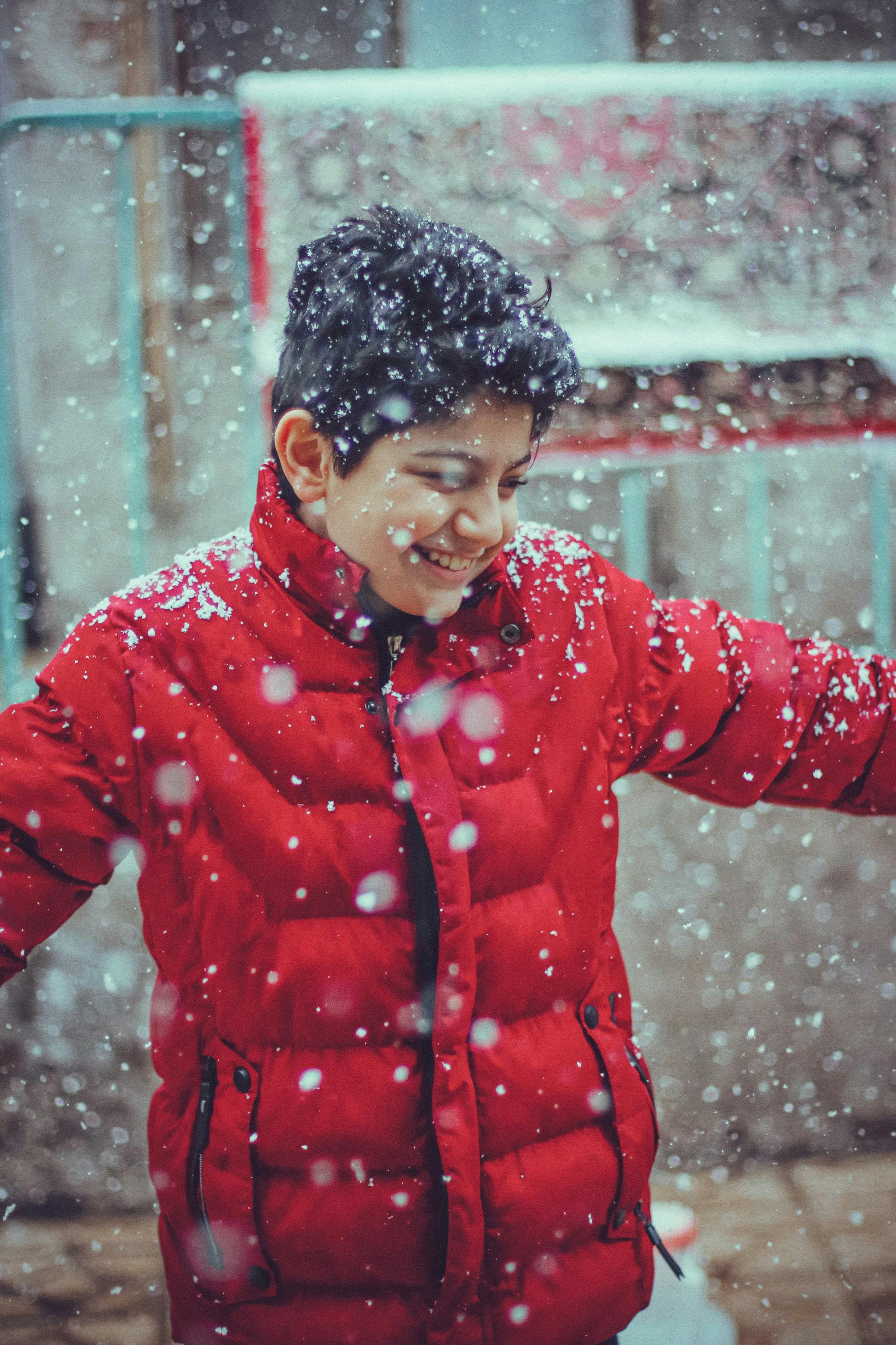 A Boy Wearing a Red Puffer Jacket · Free Stock Photo