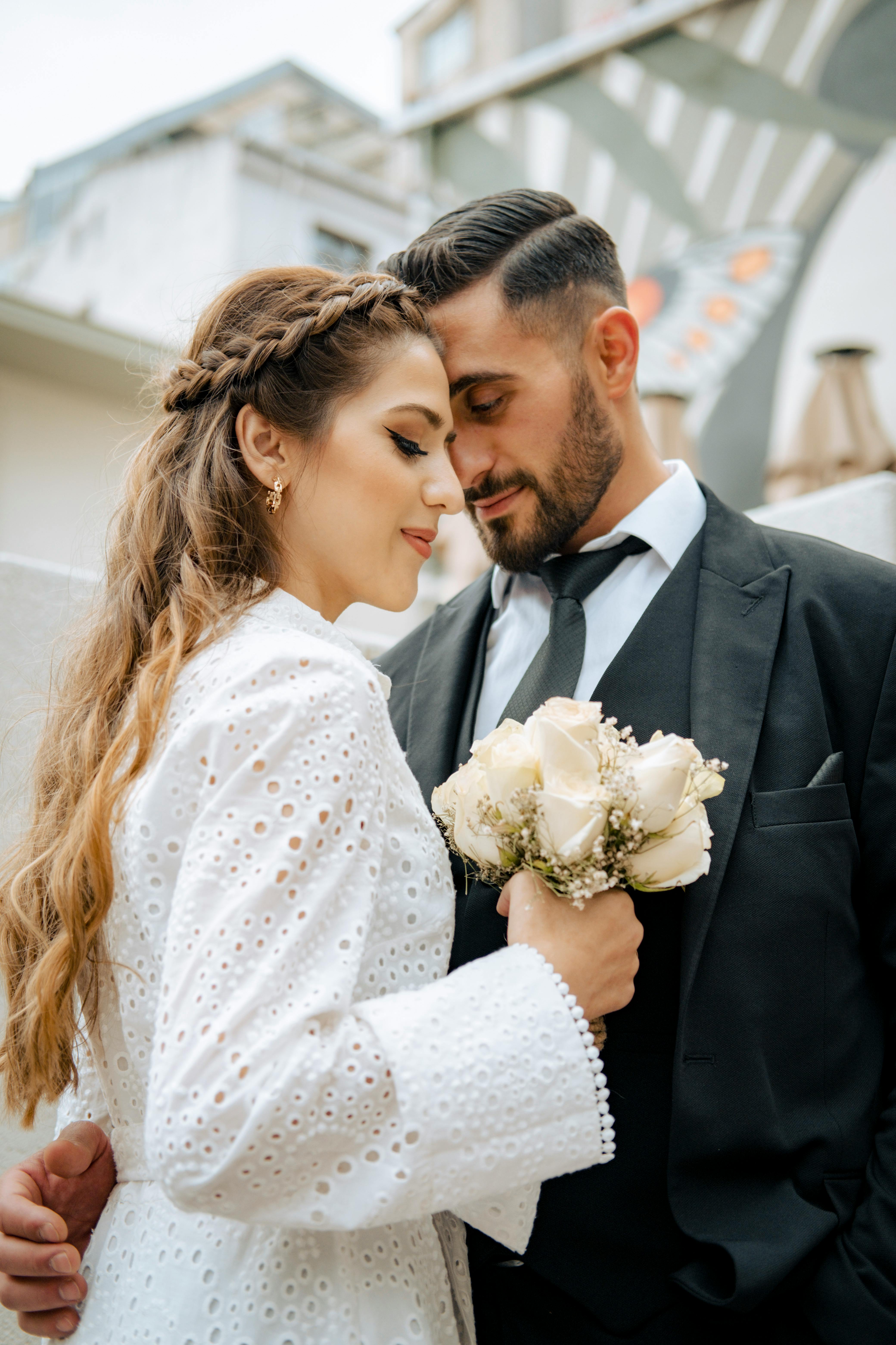 Couple with Flowers Hugging · Free Stock Photo