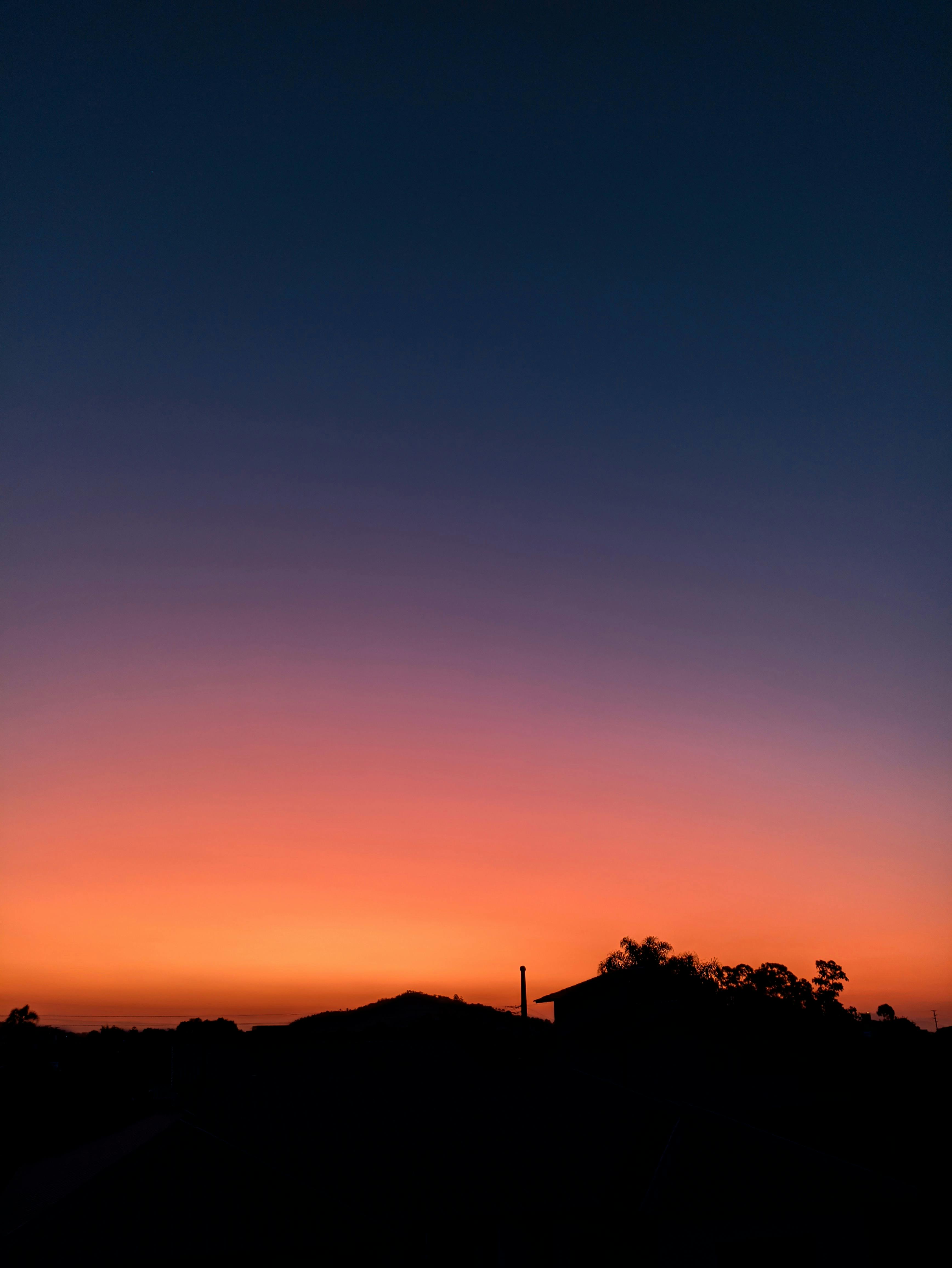 Sunset on Clear Sky over House and Tree Silhouette · Free Stock Photo