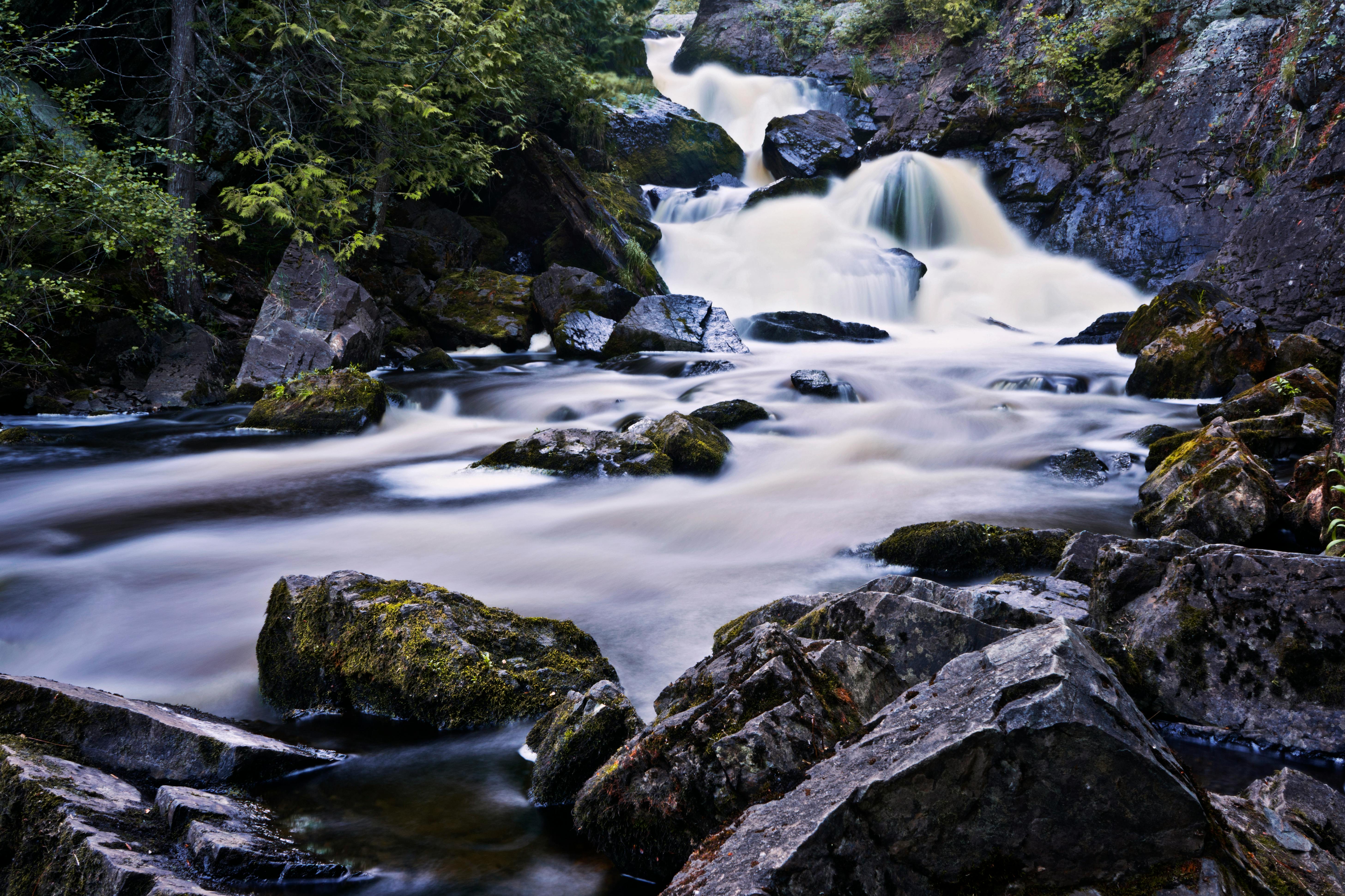 River Flowing Through Mossy Rocks · Free Stock Photo