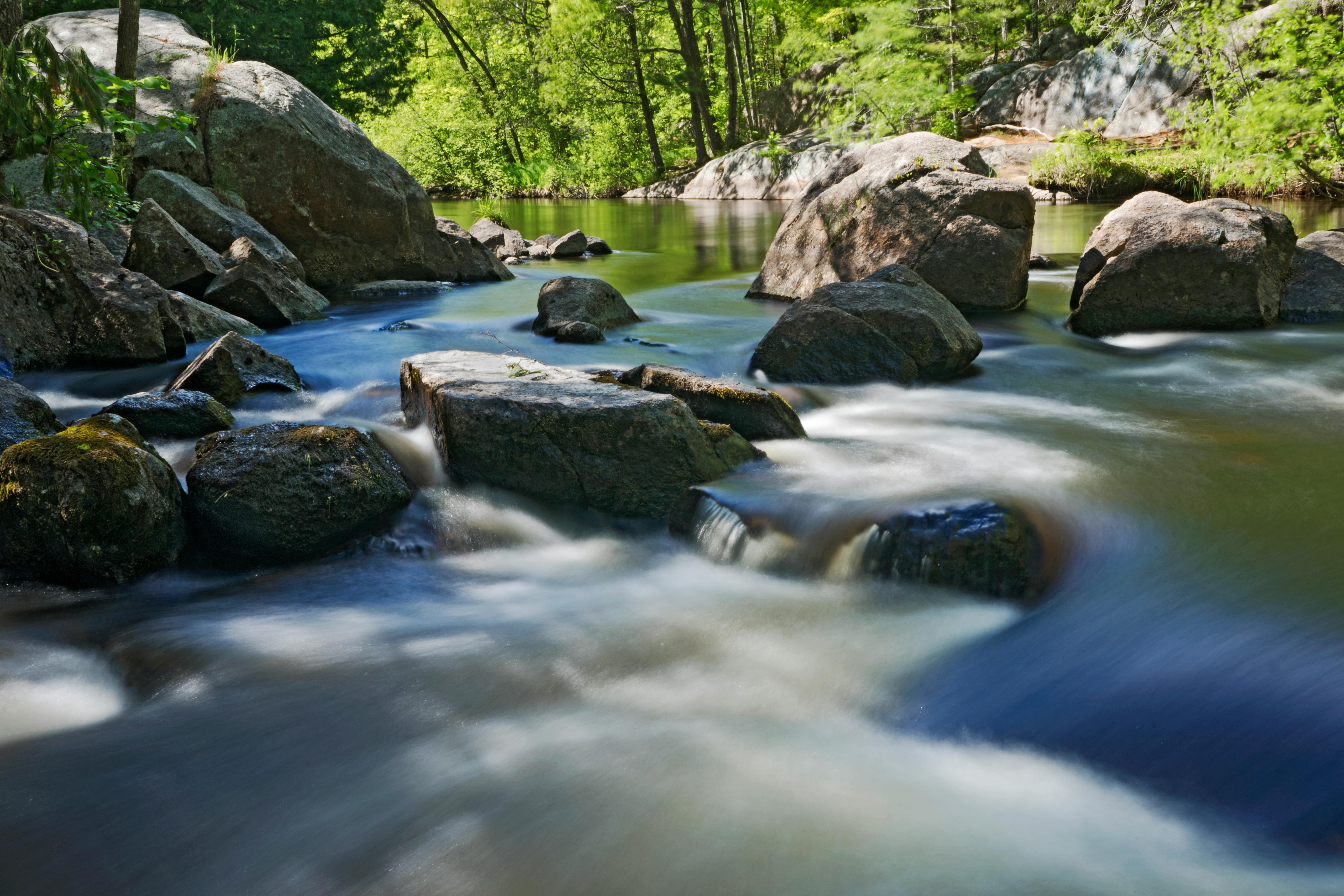 River Flowing Through Boulders and Rocks · Free Stock Photo