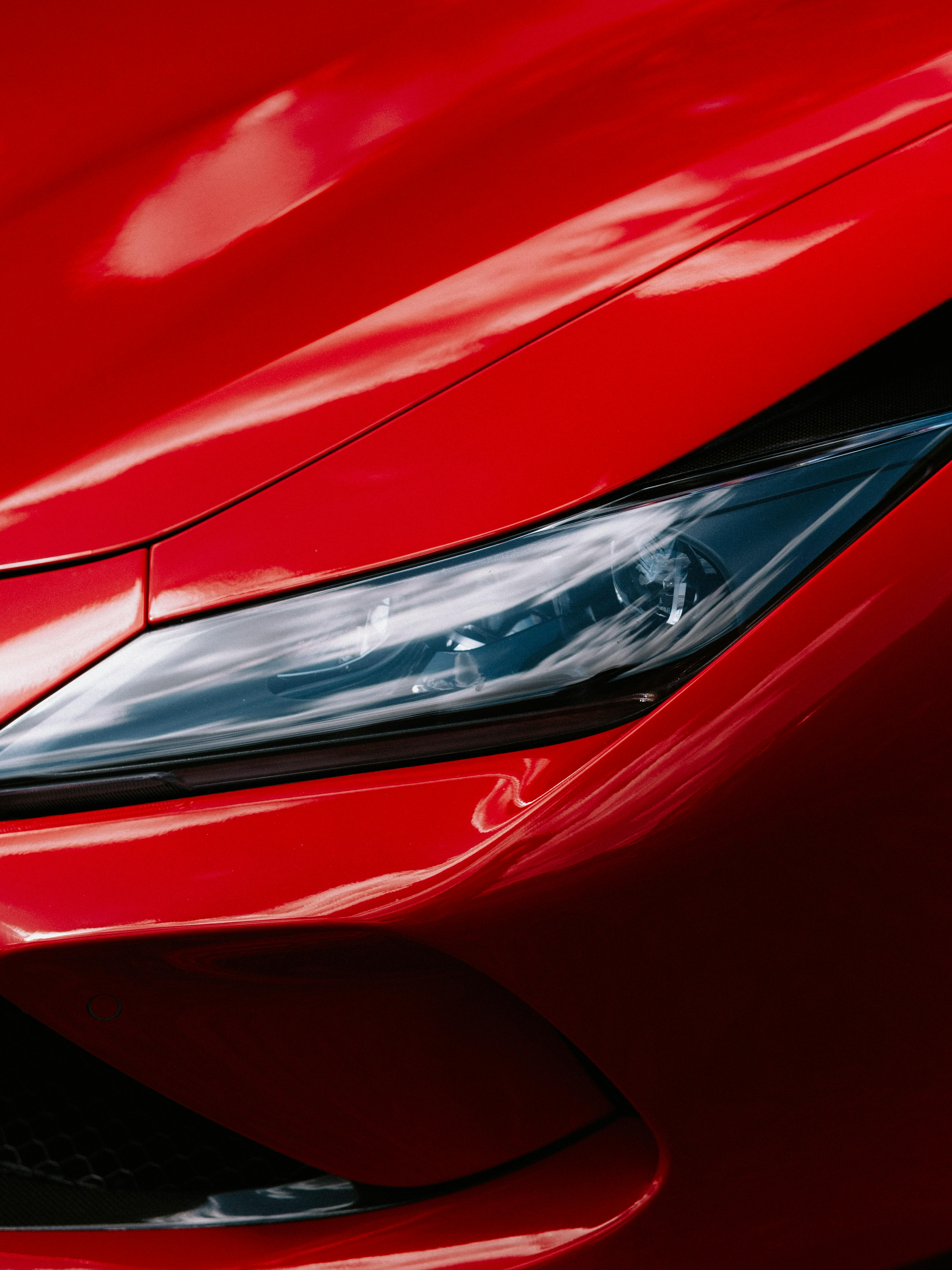 Close-Up Photograph of a Red Car's Headlight · Free Stock Photo