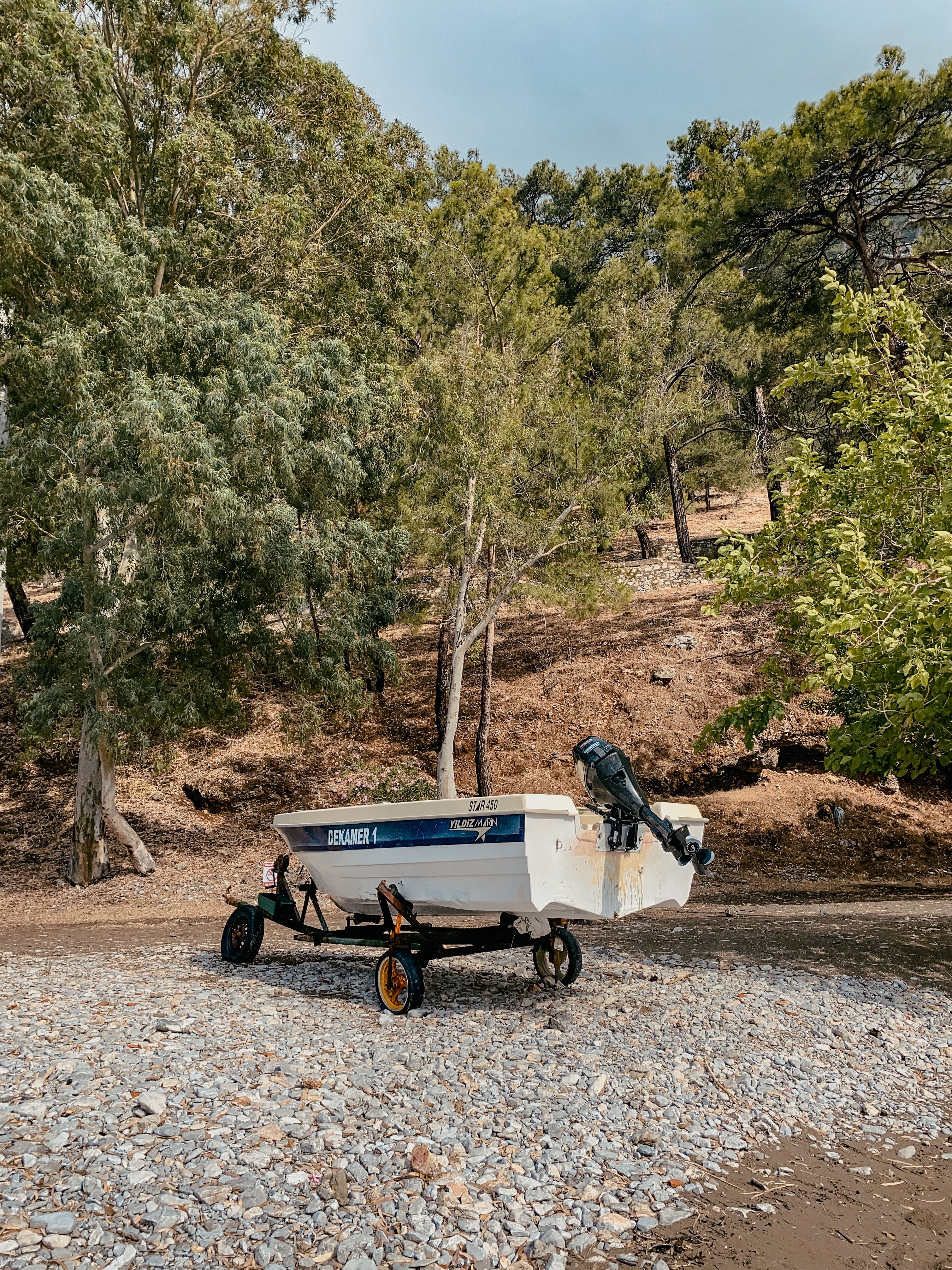 Motorboat on Trailer among Trees · Free Stock Photo