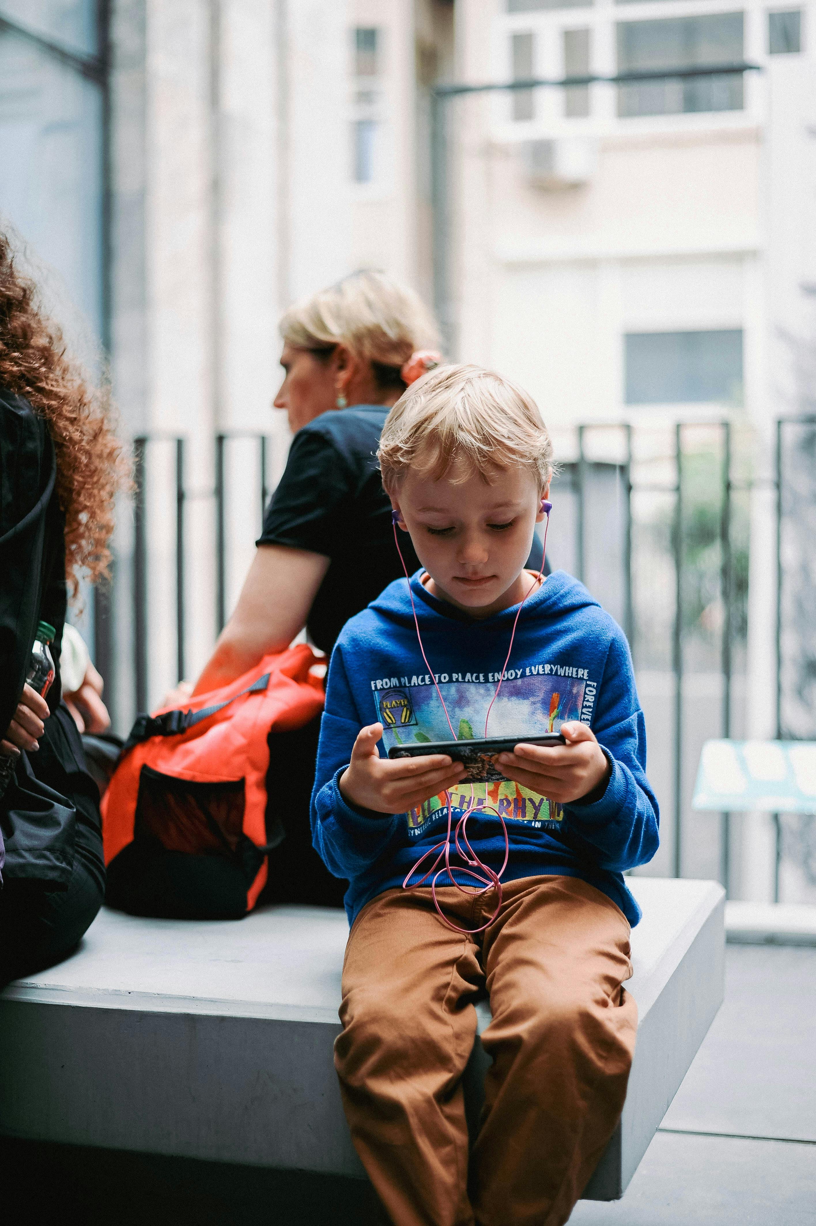 A Boy Using a Smart Phone · Free Stock Photo