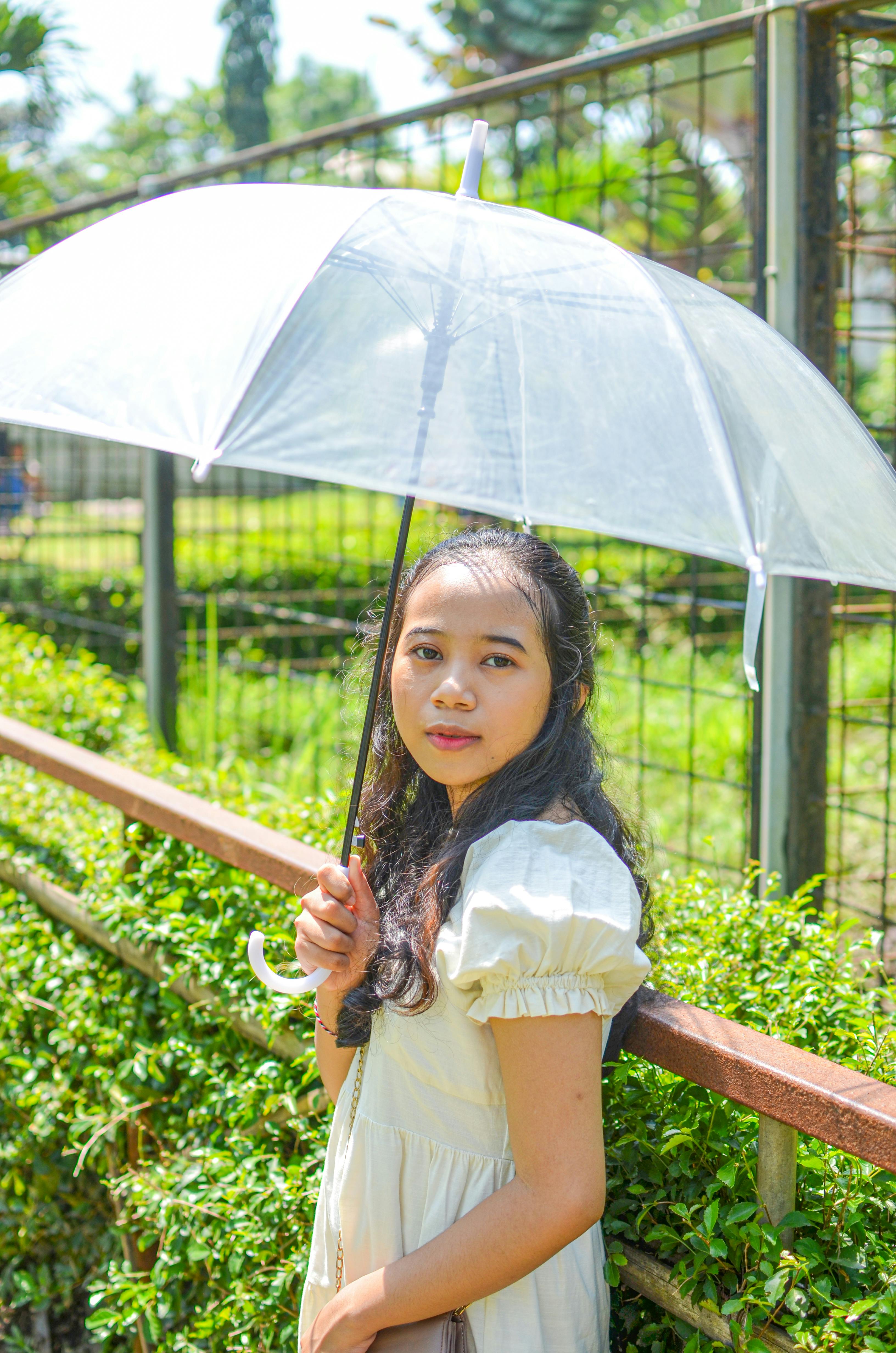 A Girl Standing on Coconut Tree Trunk · Free Stock Photo