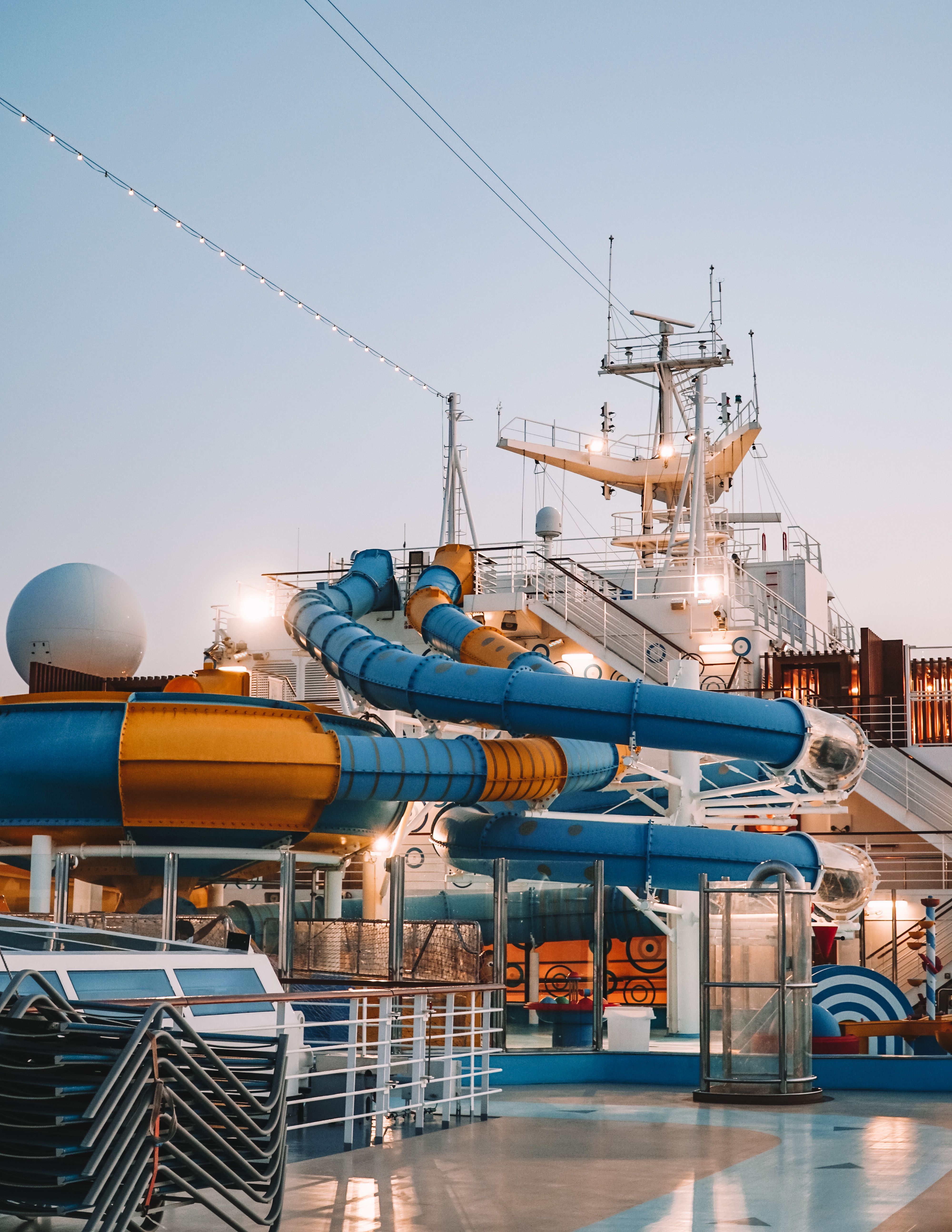 A Blue and Orange Spiral Tube Slide on a Ship Deck · Free Stock Photo