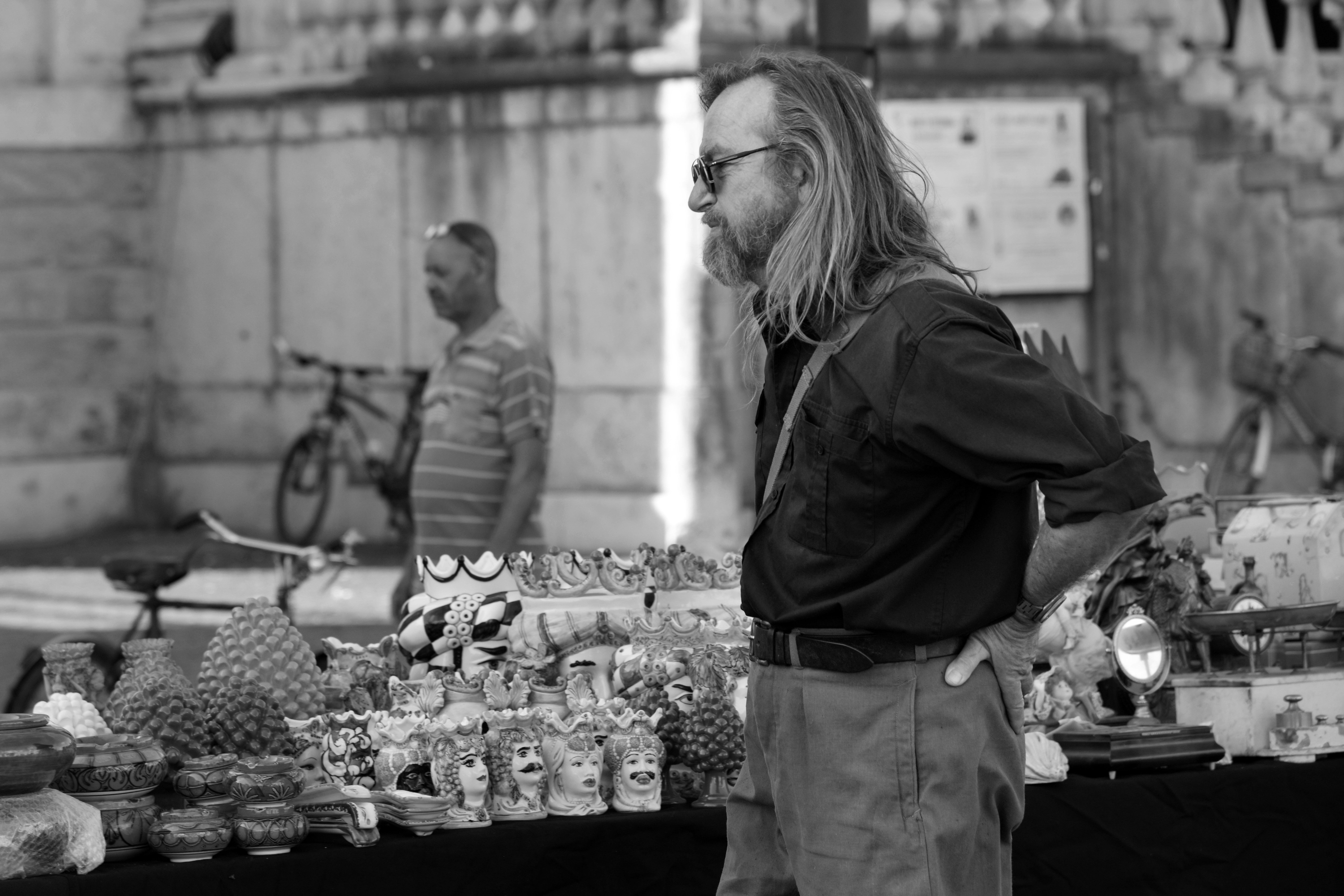 Man Standing by a Market Stall · Free Stock Photo