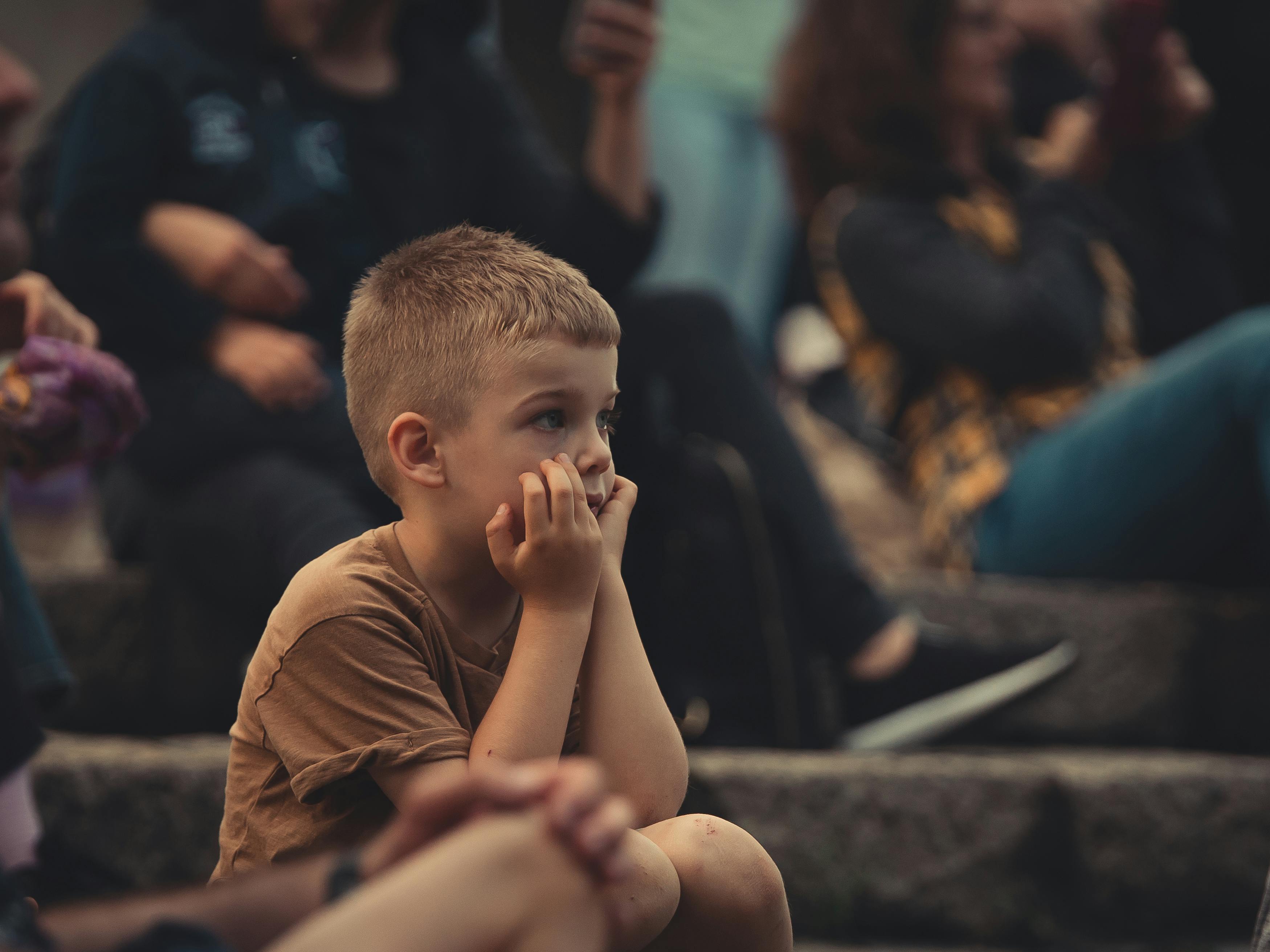 Photo of a Kid Posing with Her Hand on Her Chin · Free Stock Photo