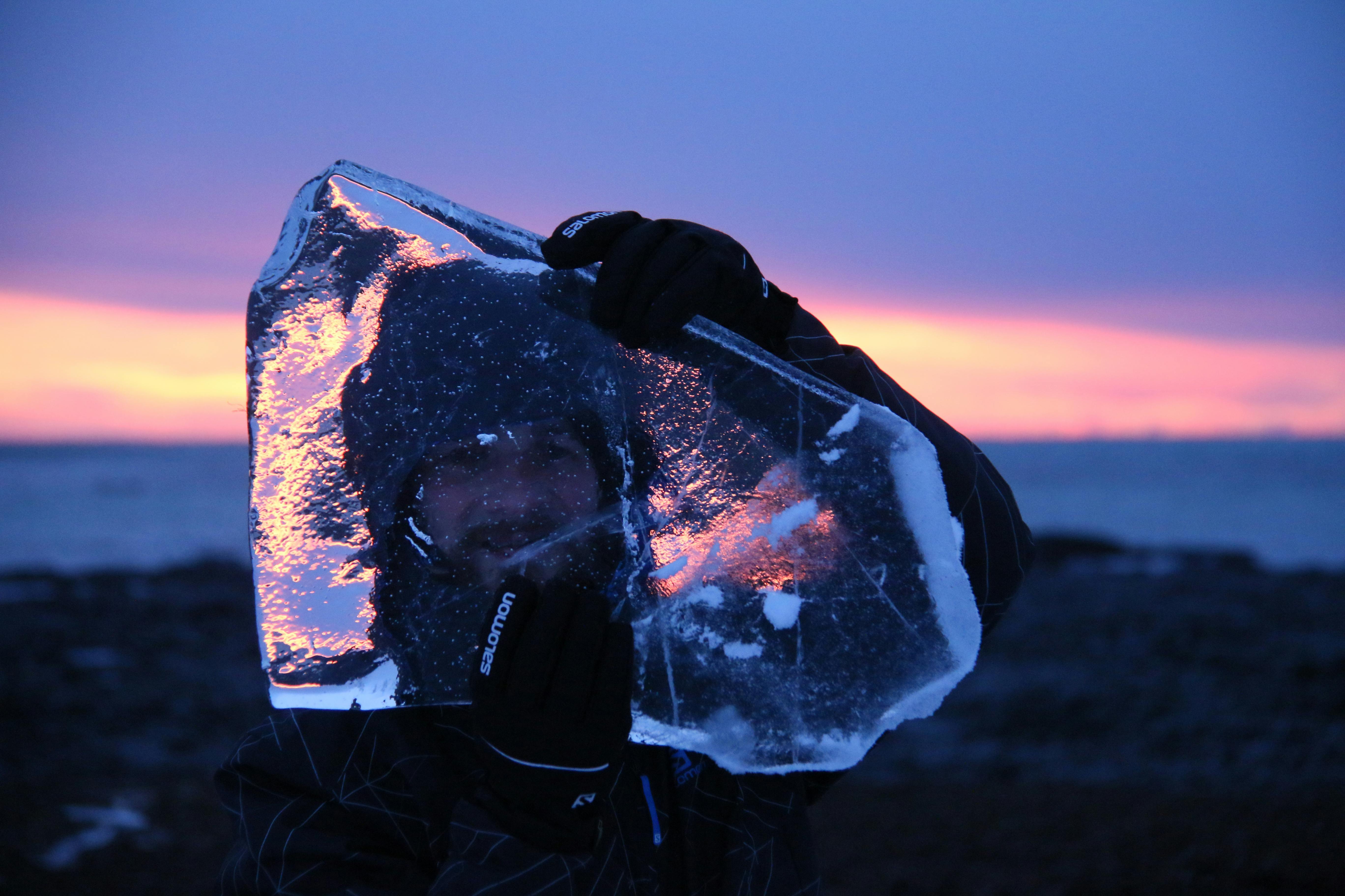 Person Carrying Block of Ice While Standing on Hill · Free Stock Photo