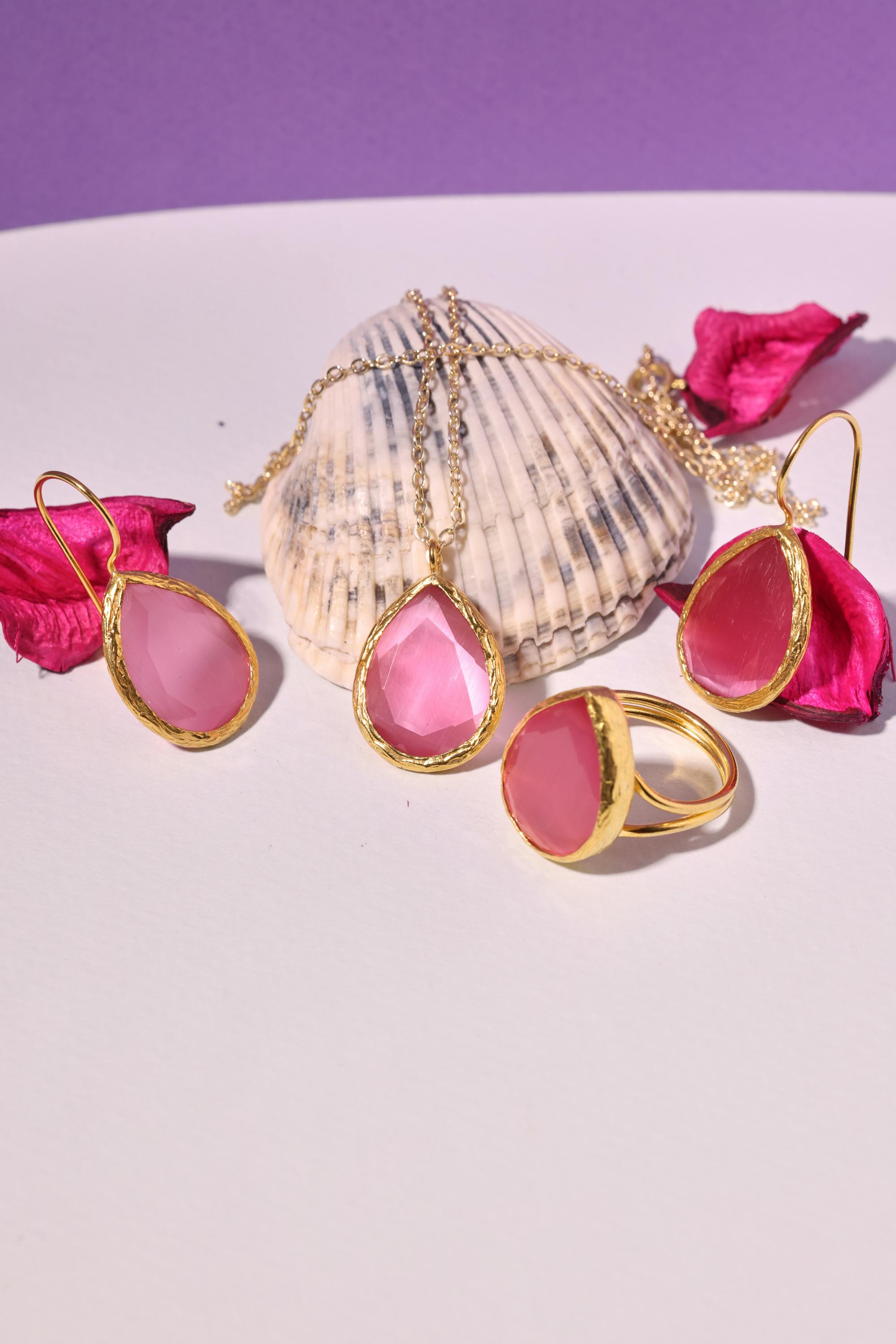 A Set of Pink Gemstone Jewelries on White Surface · Free Stock Photo