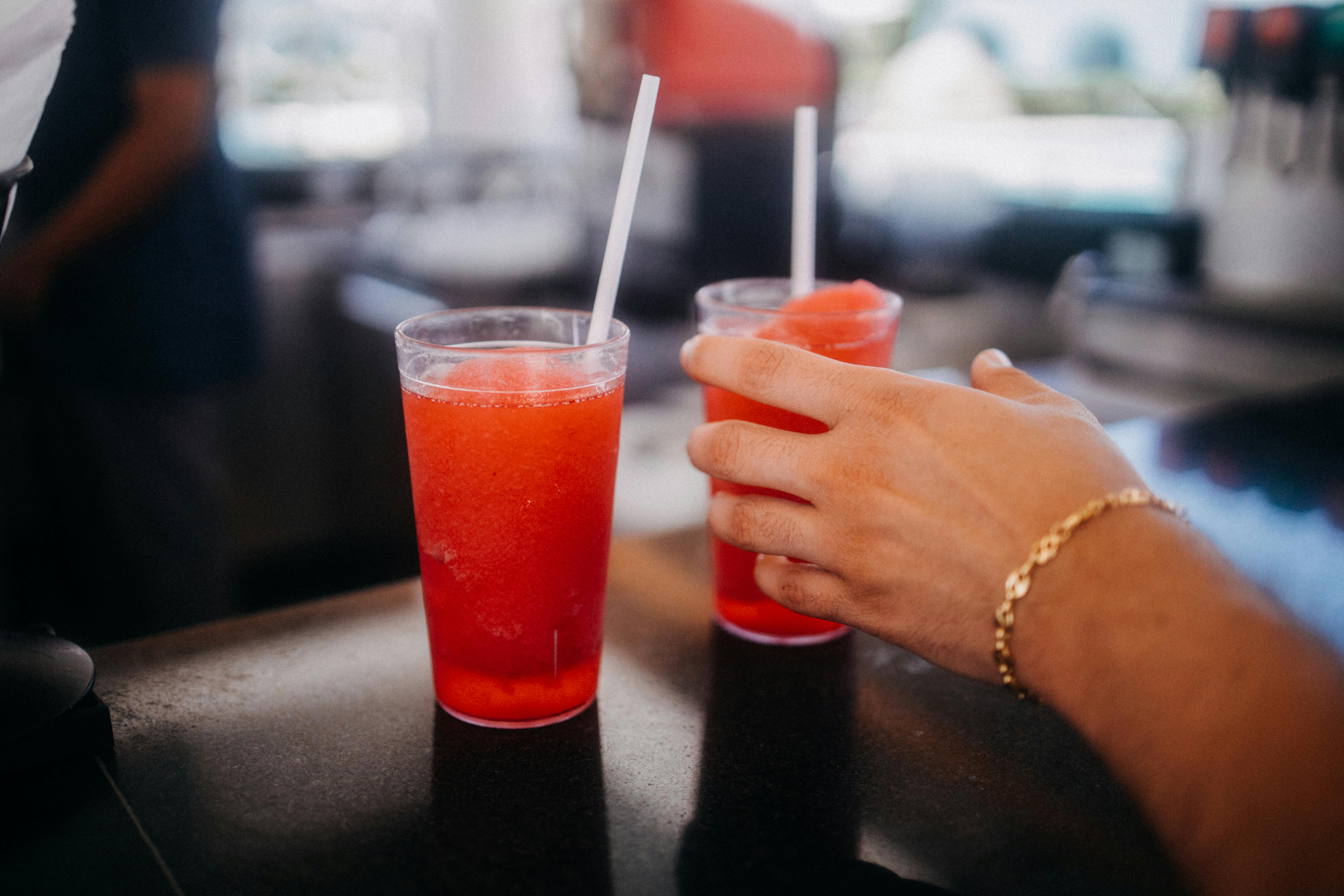 A Person Holding Icee Drinks · Free Stock Photo