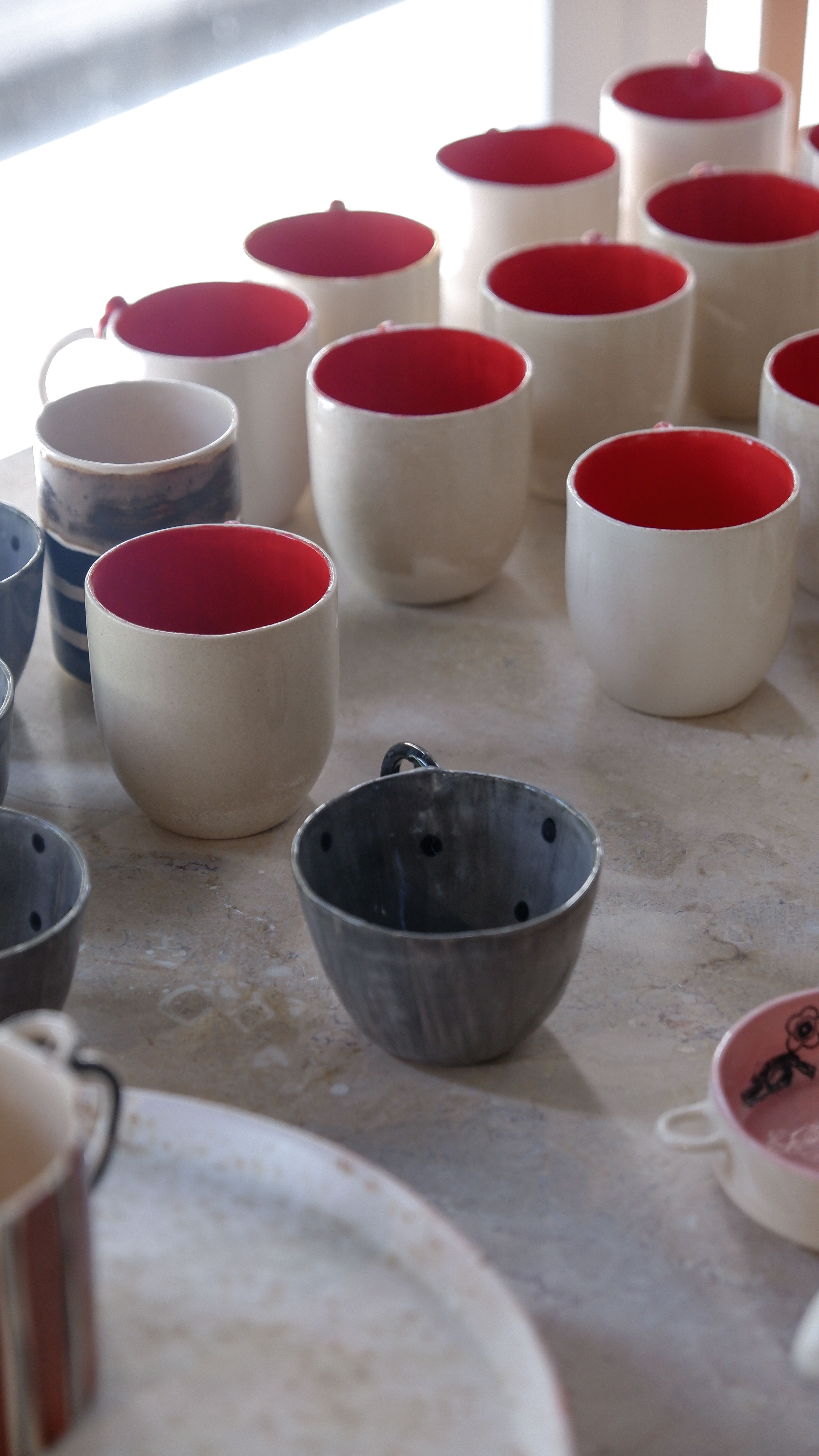 Close-Up Shot of Ceramic Cups on Concrete Surface · Free Stock Photo