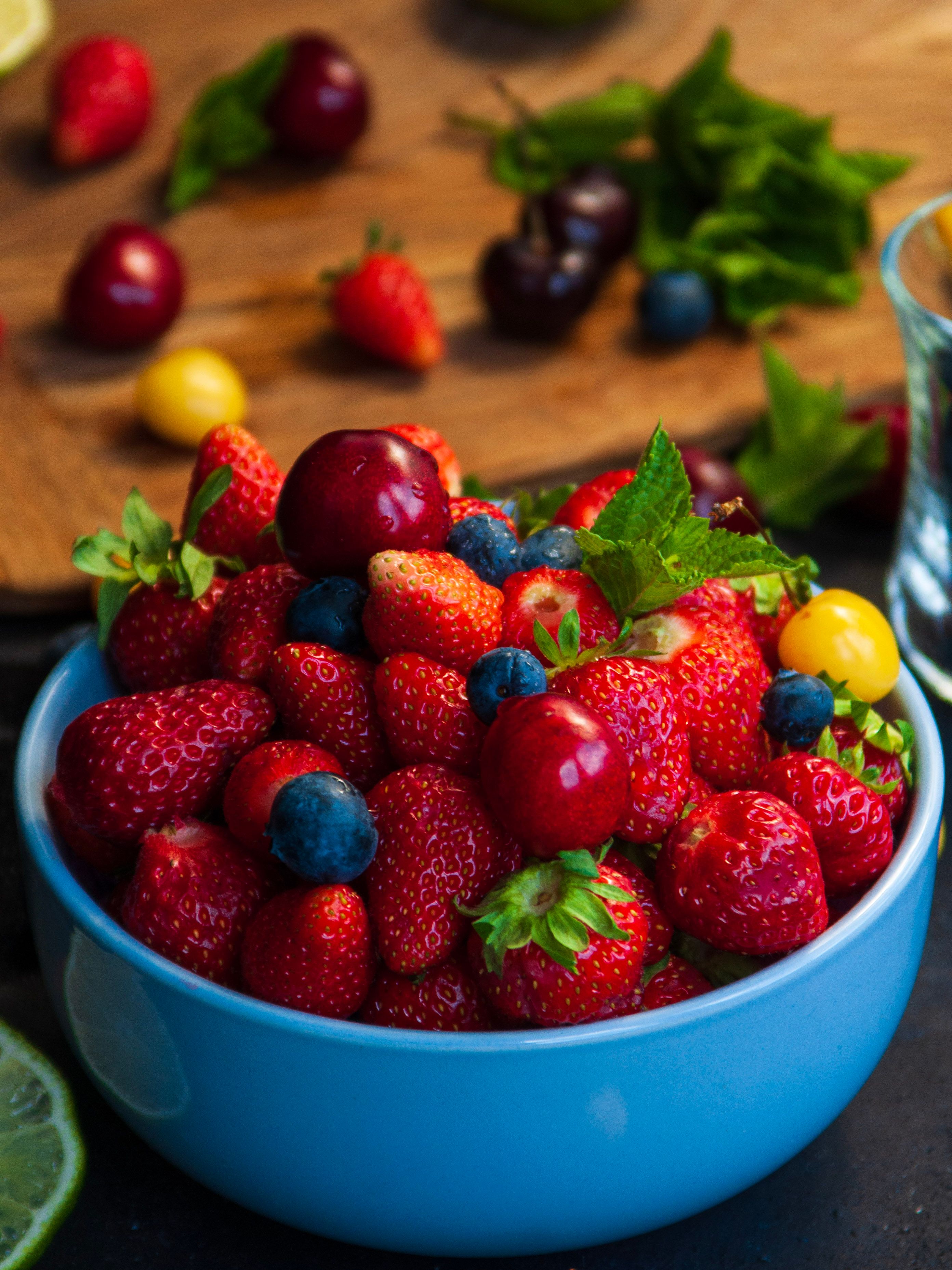 Black Berries With Sliced Fruits on White Plate · Free Stock Photo
