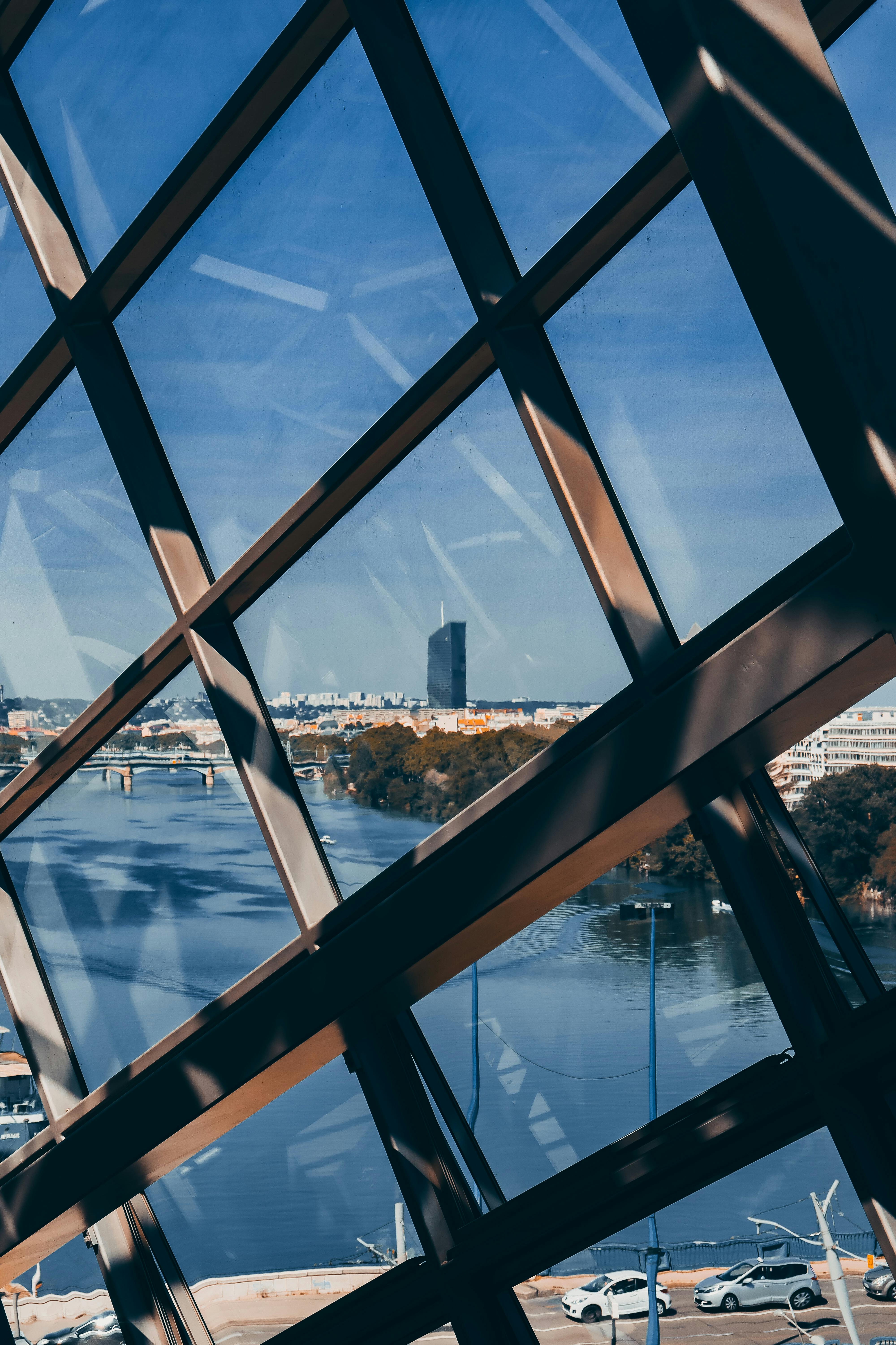 Photo of a Cityscape with a Skyscraper through Window · Free Stock Photo