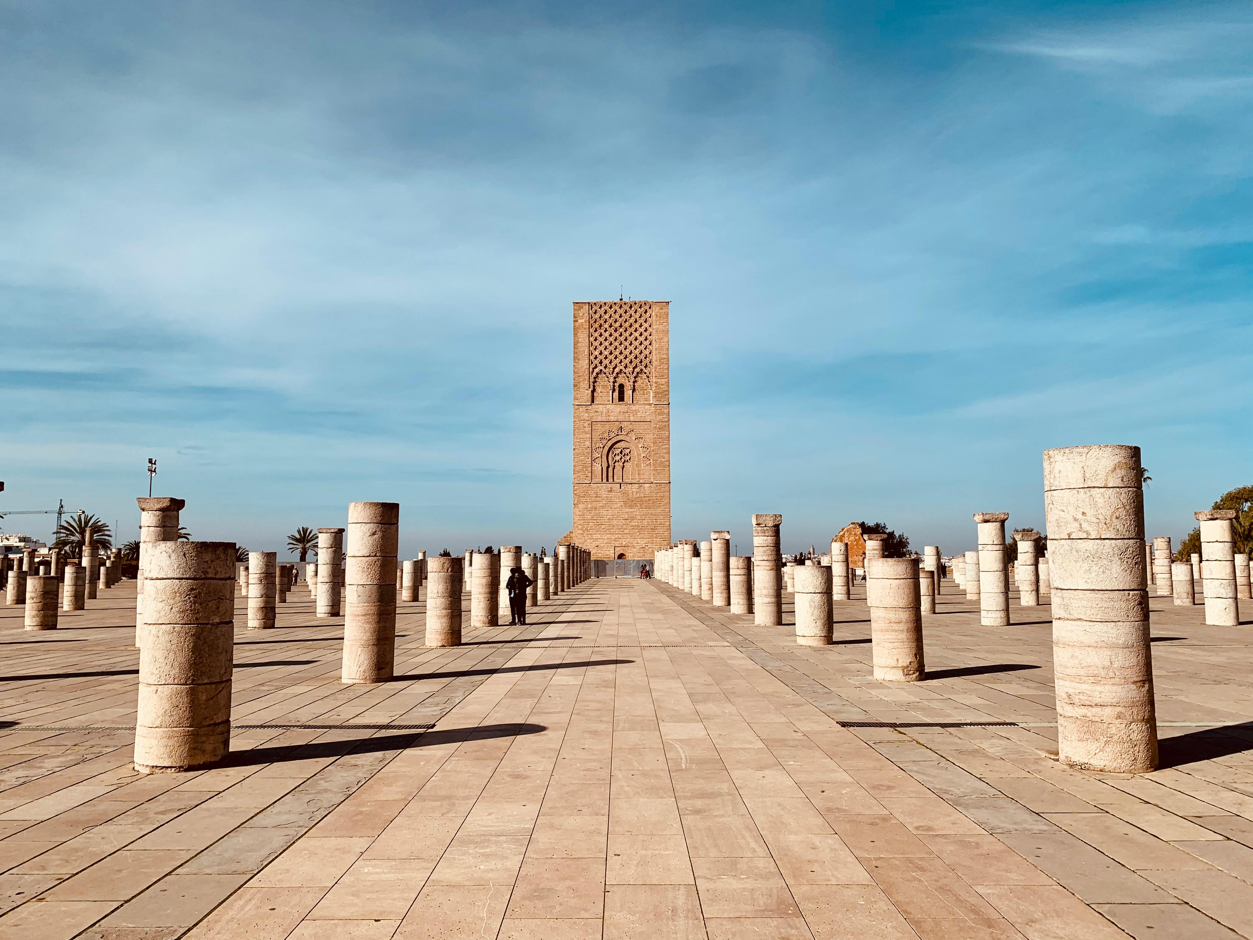Man Standing Under An Arch Of Building · Free Stock Photo