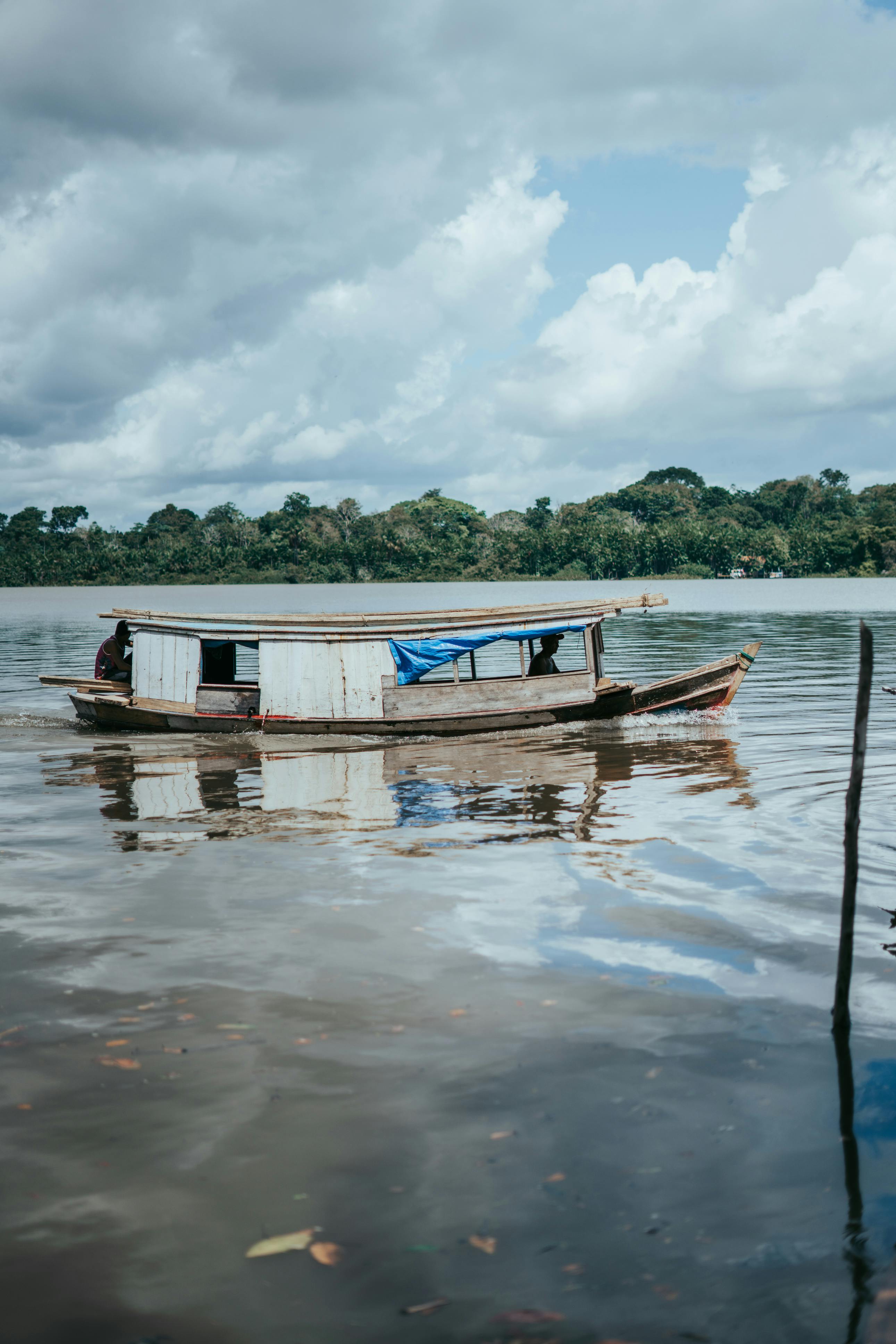 Woman Wearing Black Cap Holding Bottle on White Speedboat during ...