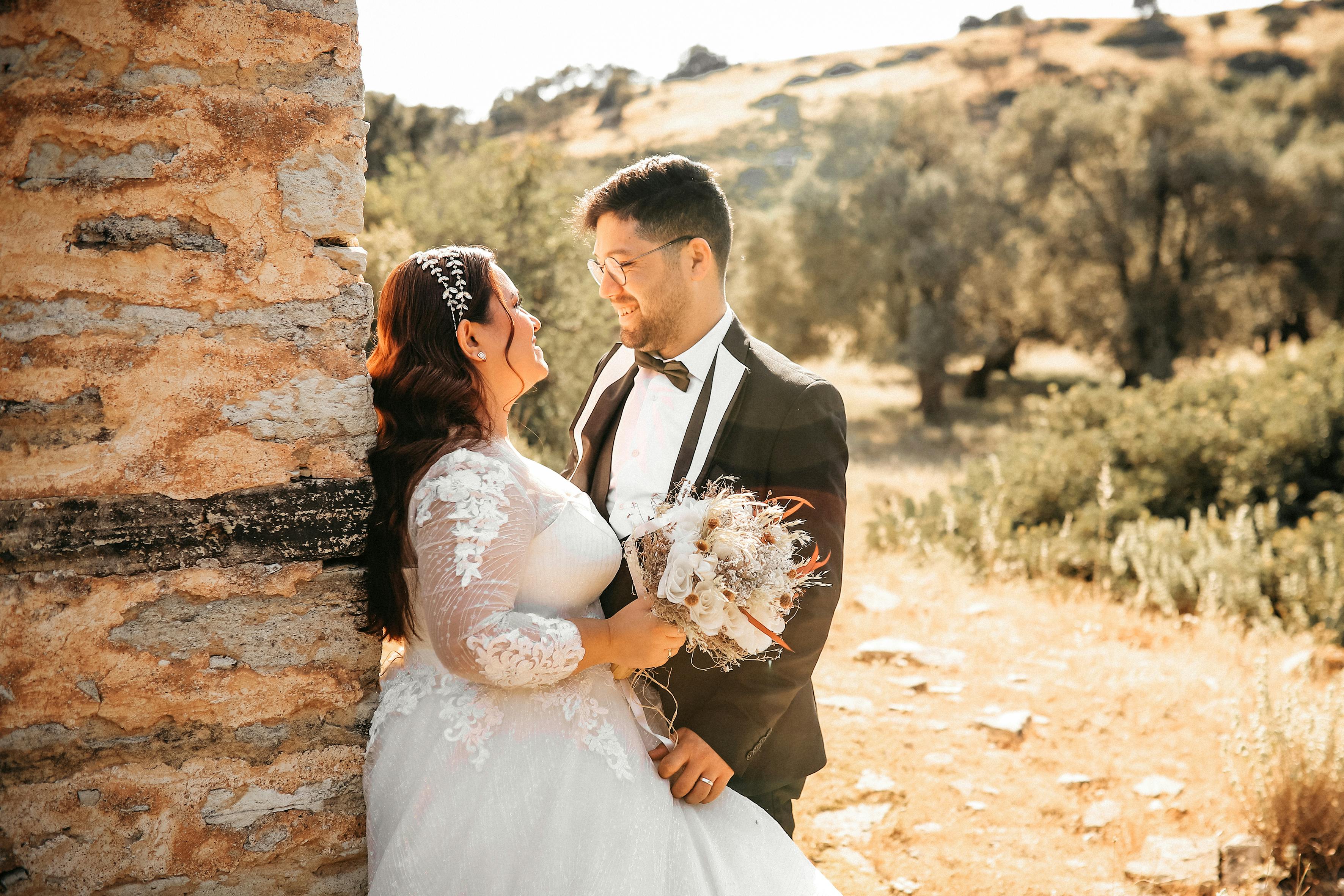 Photo of Married Couple Standing on Grass While Smiling · Free Stock Photo