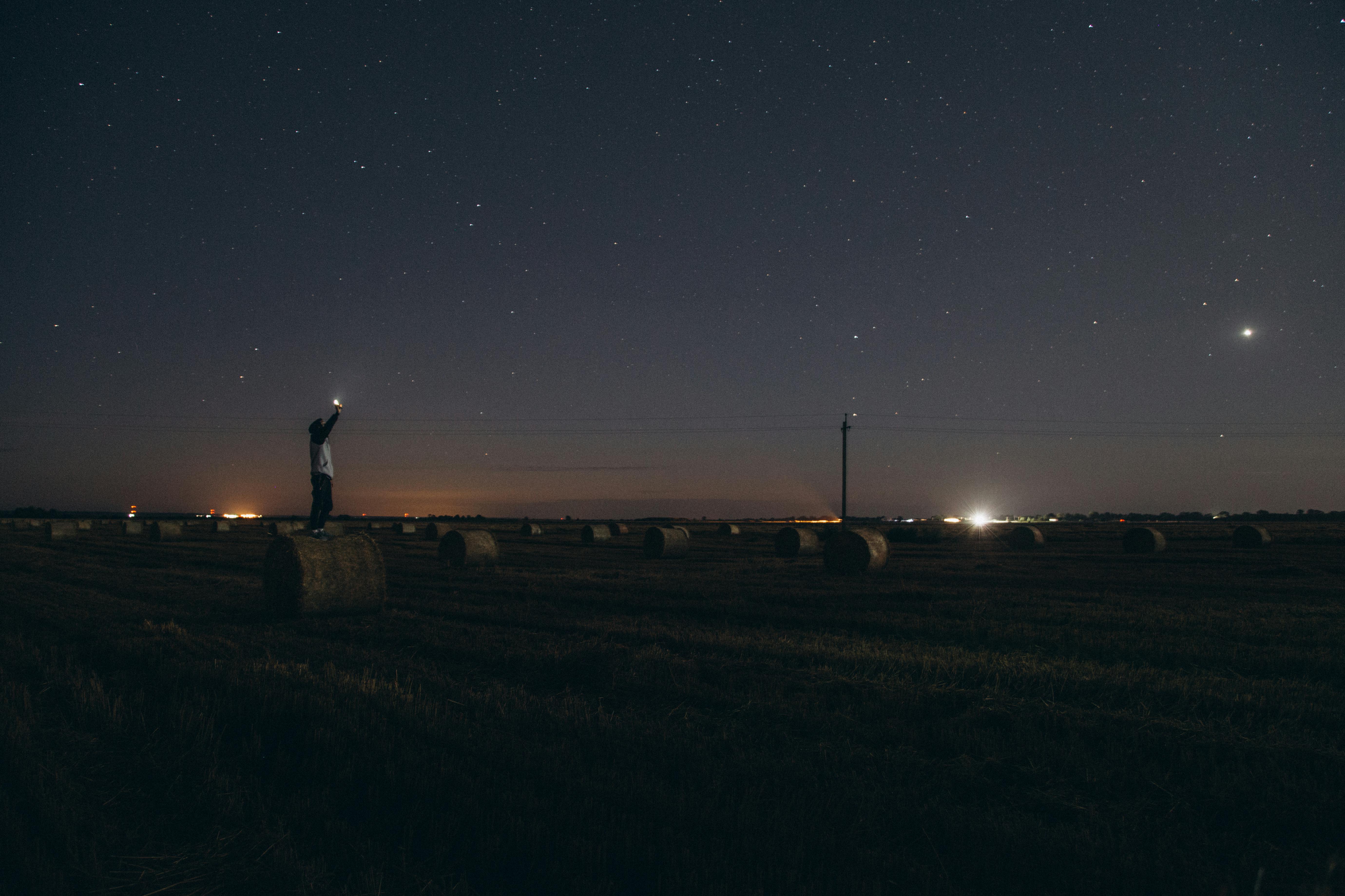 Man Reaching Stars on Field · Free Stock Photo