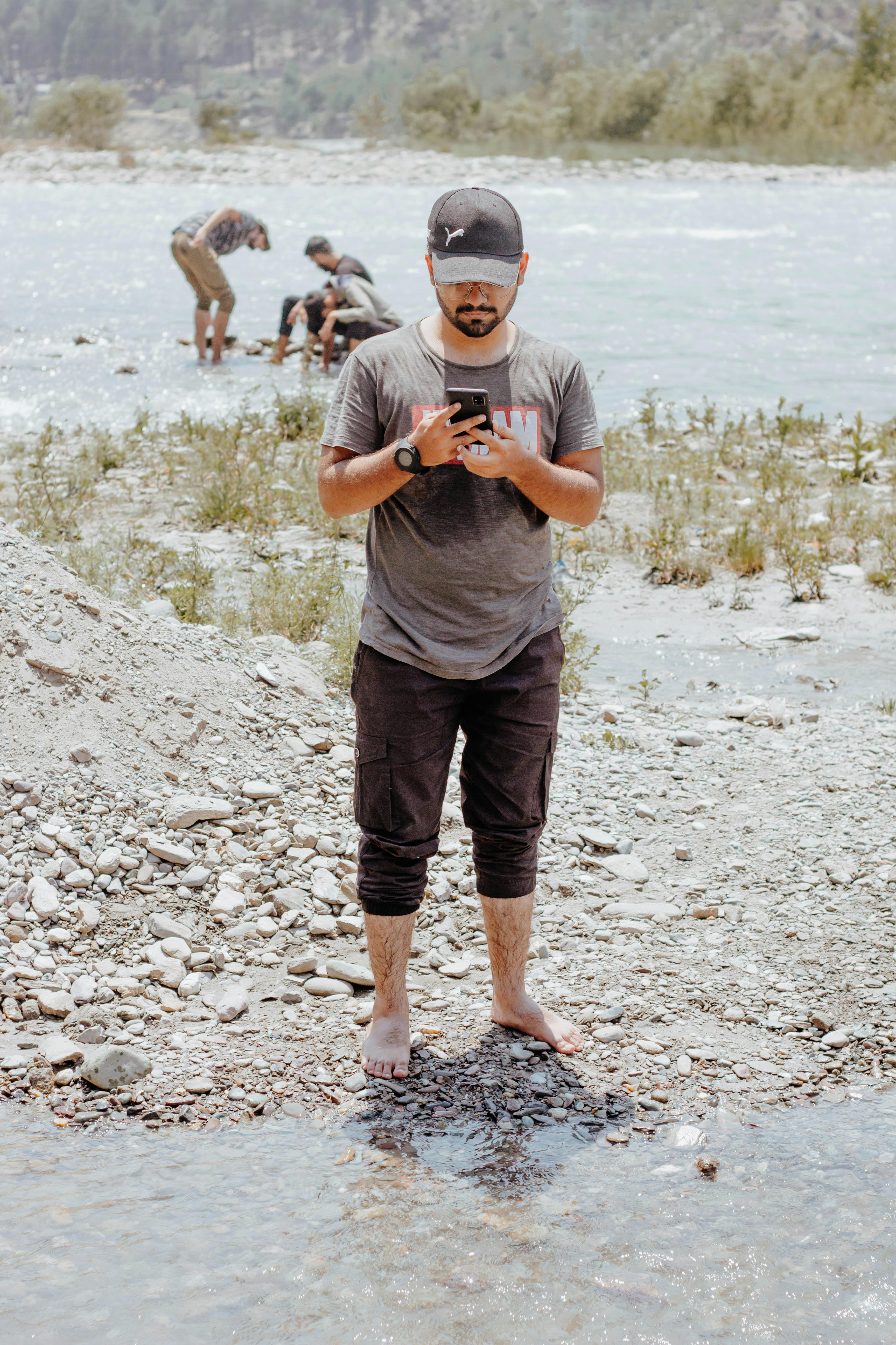 A Man Standing Beside the River · Free Stock Photo