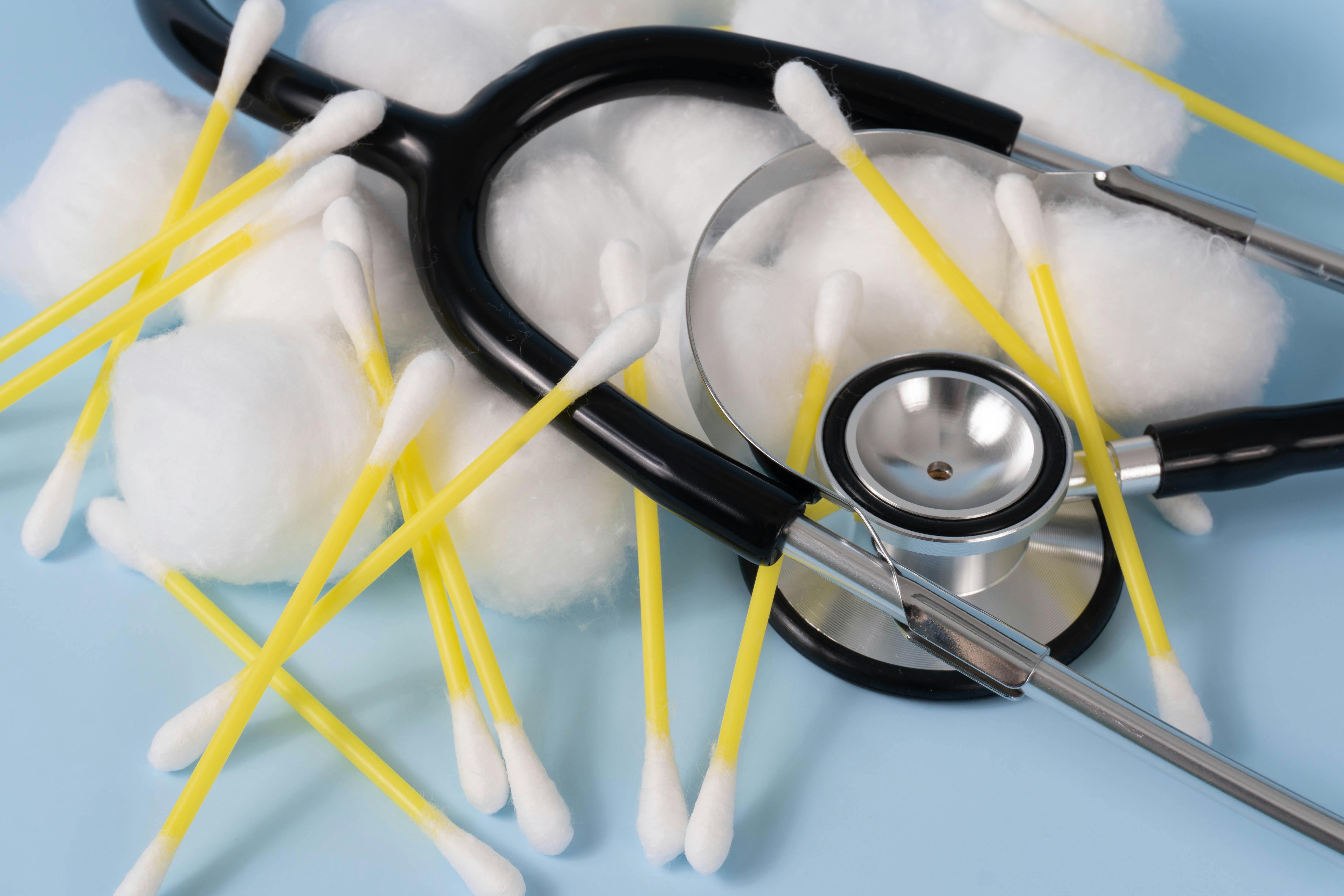 Stethoscope Beside Cotton Buds and Cotton Balls on a Blue Surface ...