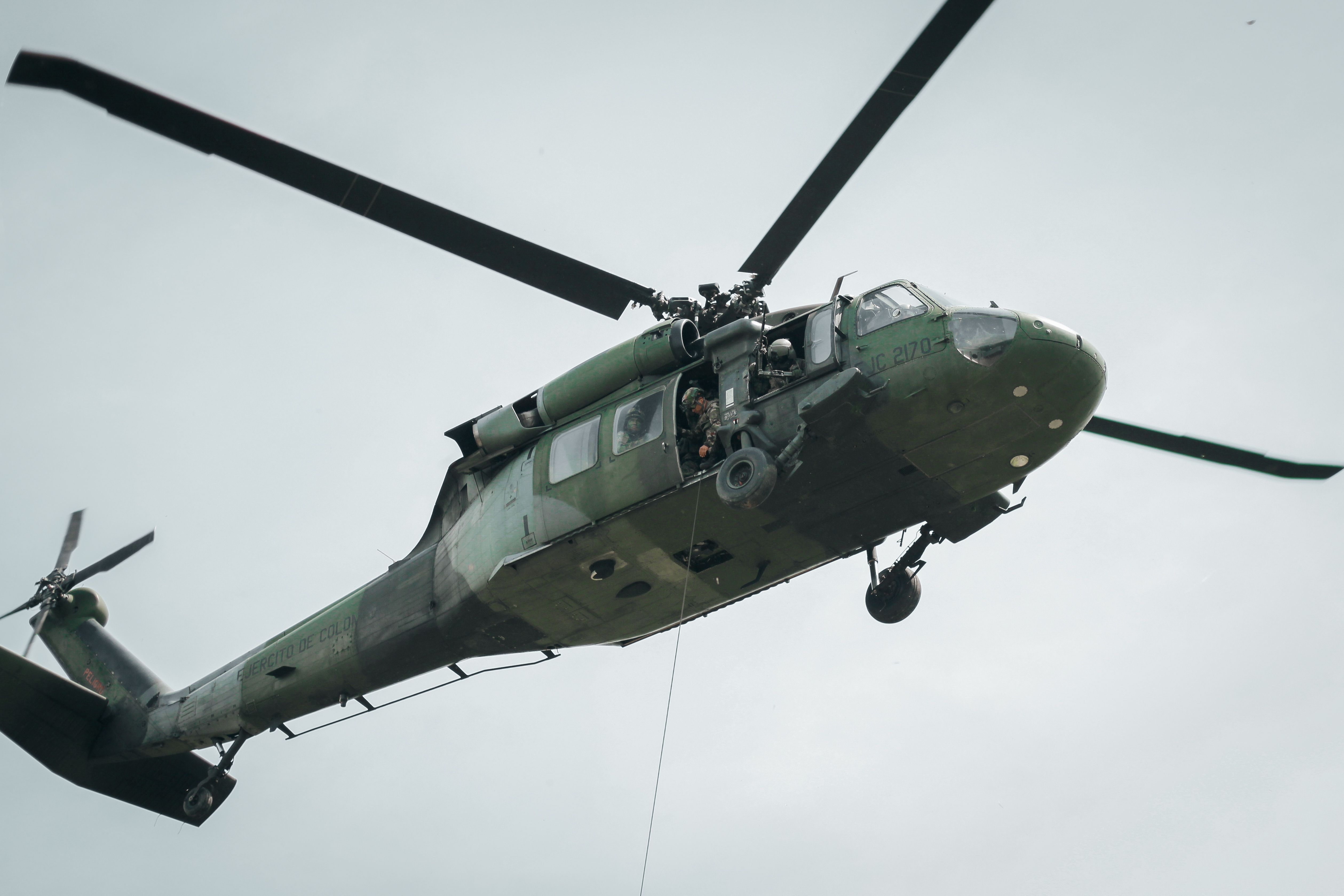 A Us Army Helicopter Hovering Above A Group of Soldiers · Free Stock Photo