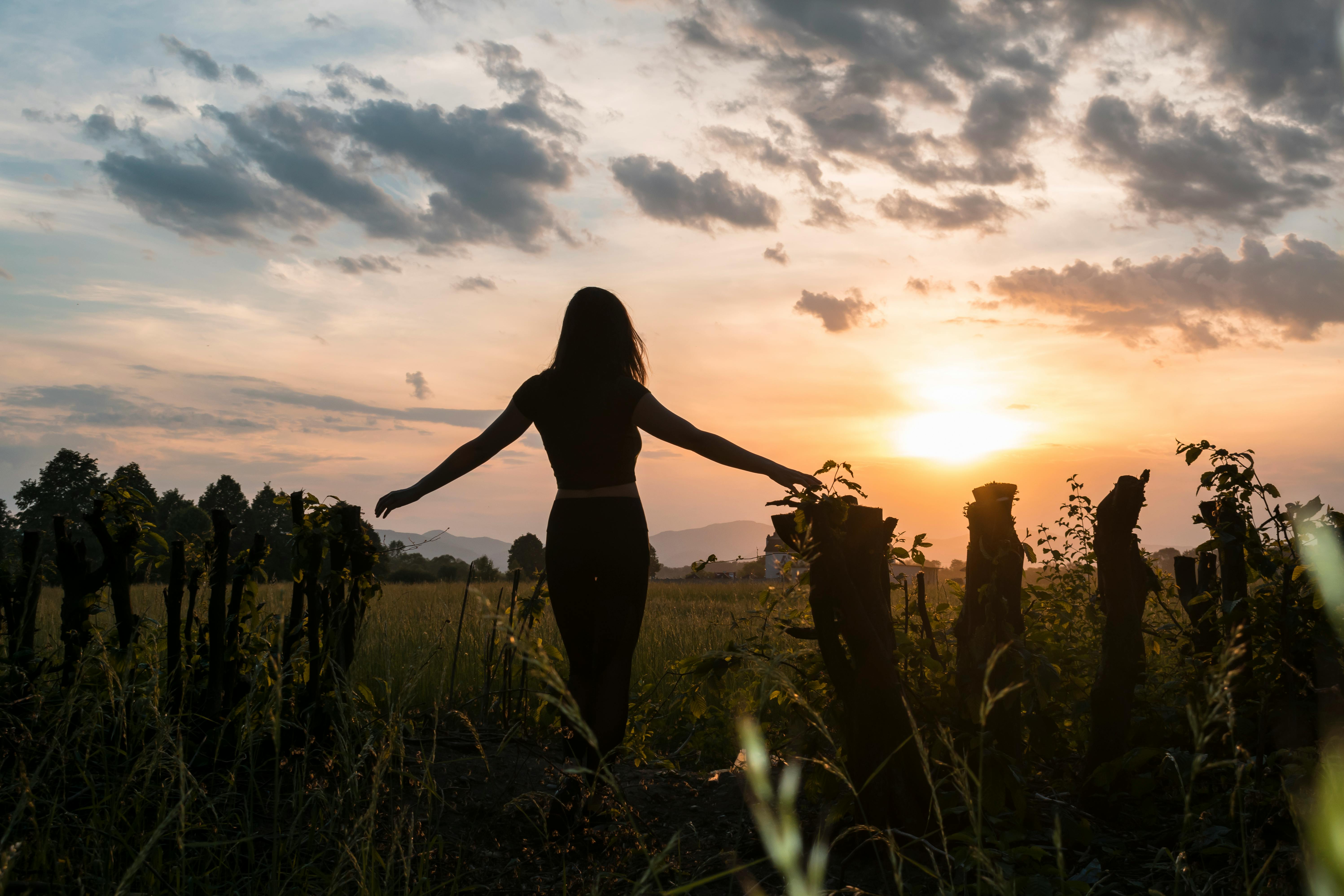 Rear View of Woman Standing in Balcony during Sunset · Free Stock Photo